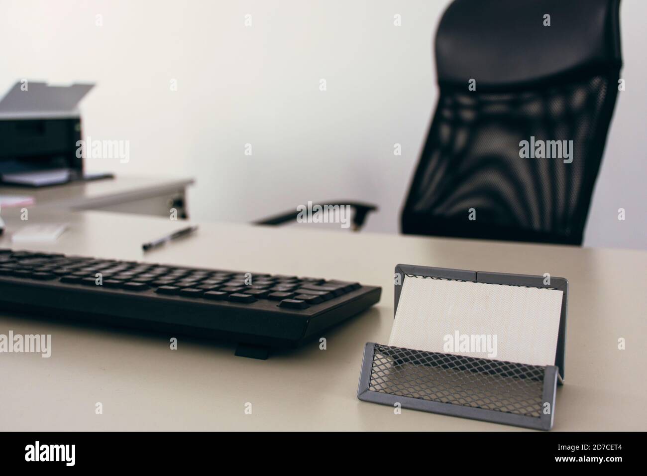 Low angle view of office space with a chair and a keyboard on a white ...