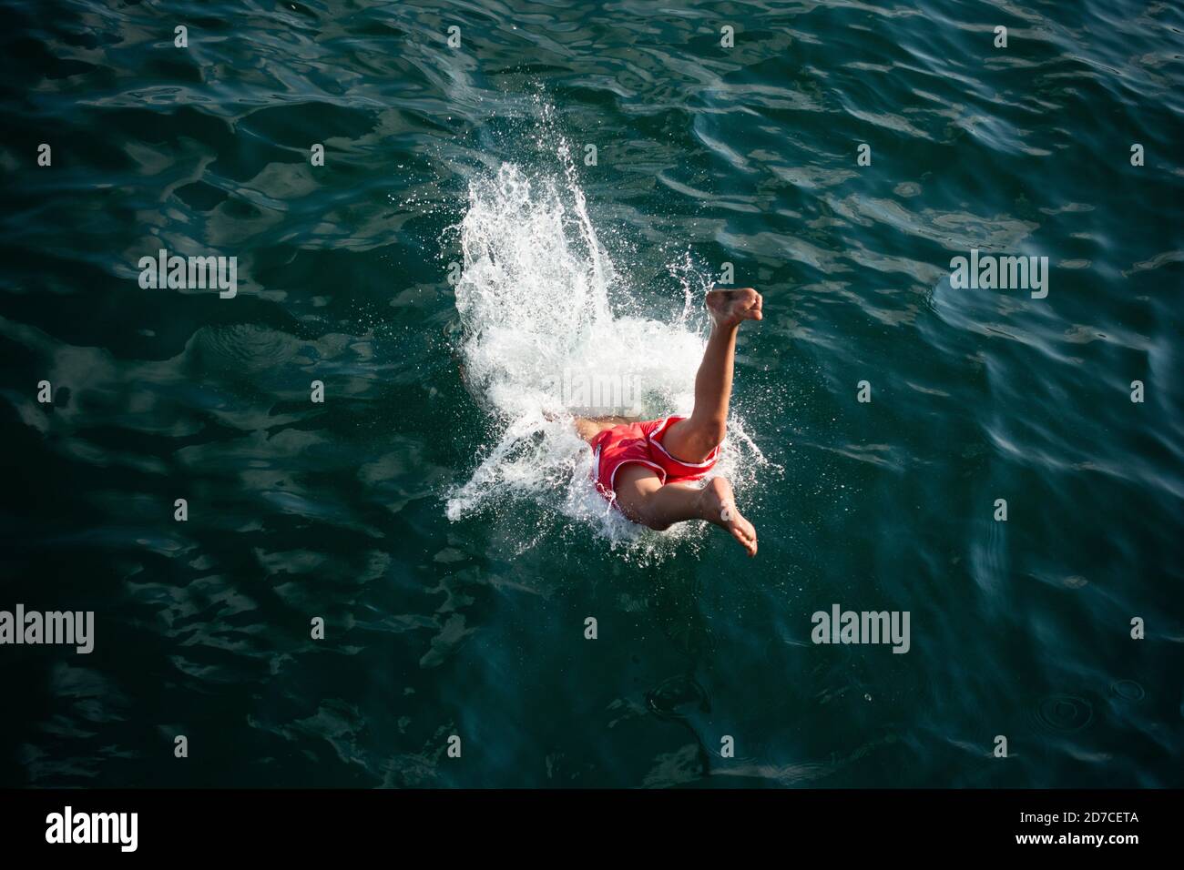 High angle shot of a person diving into the sea Stock Photo - Alamy