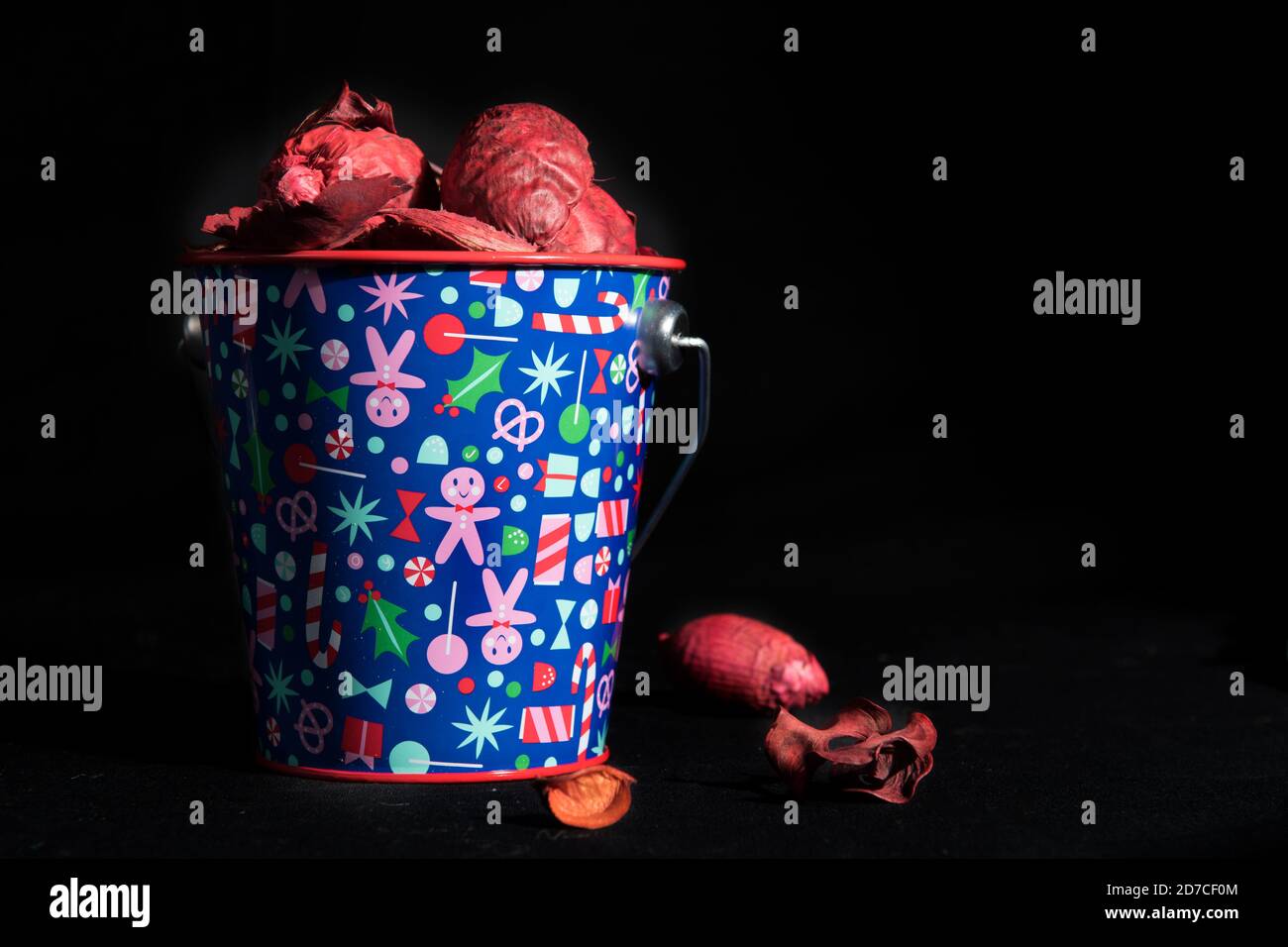 Children’s Christmas bucket with ornaments filled with red potpourri on ...