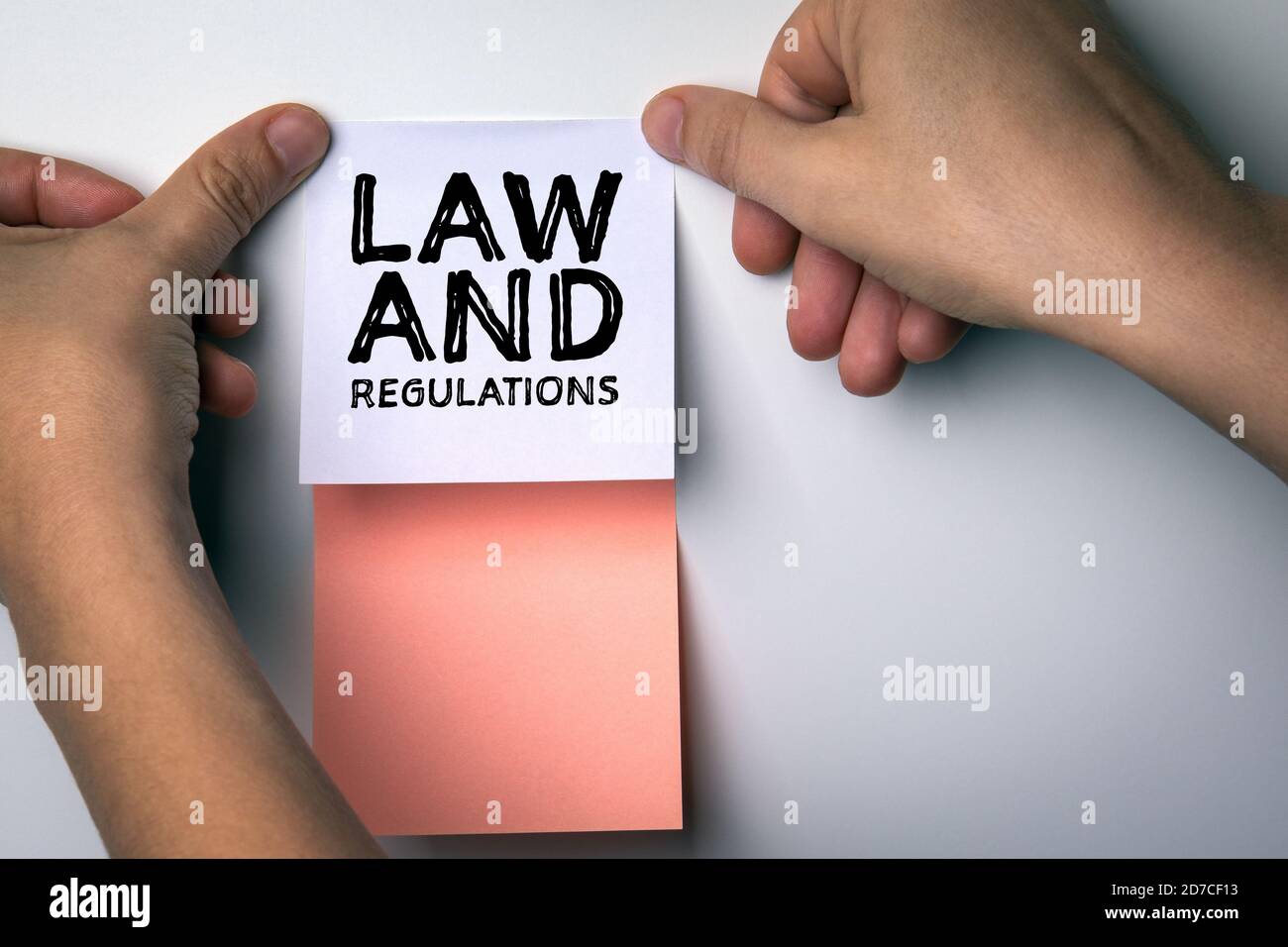 LAW and REGULATIONS concept. Colored sticky notes on a white wall Stock ...