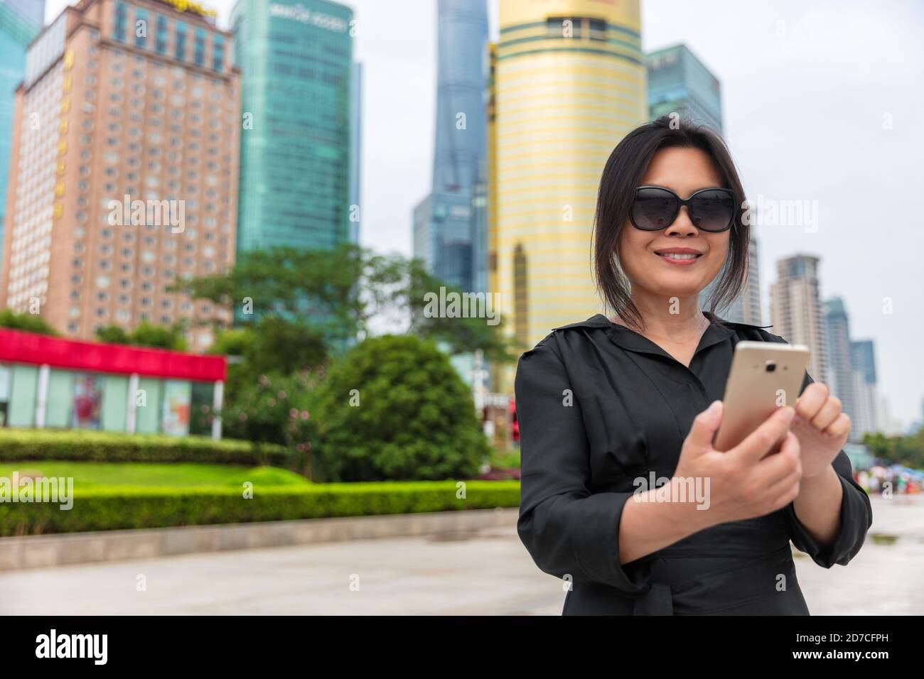 Mobile phone city lifestyle busy real estate chinese businesswoman lady ...