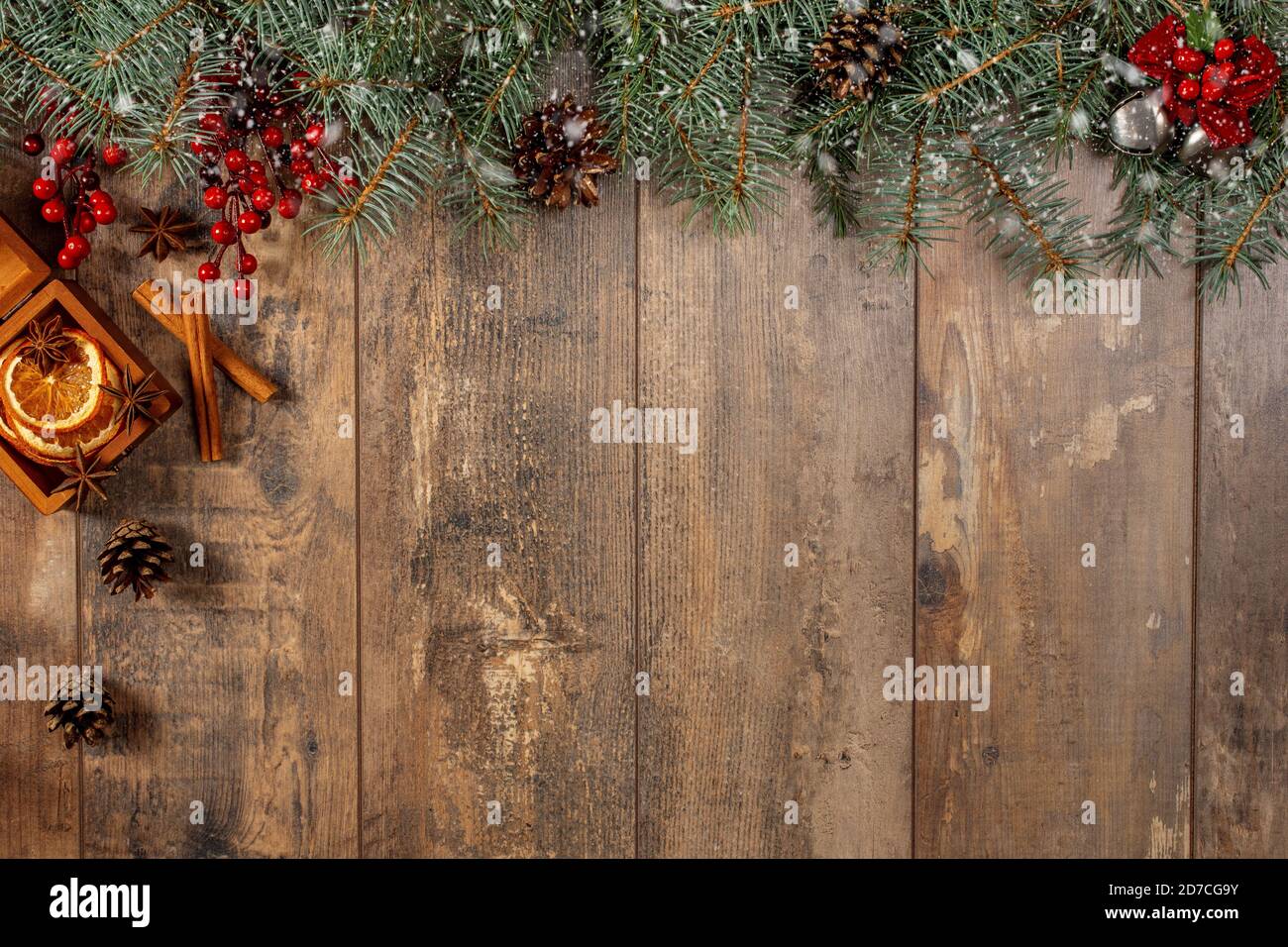 Green Christmas tree pine leaves and snow on wood table background ...