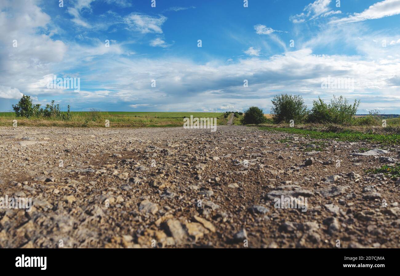 Low angle view of rural stone road and fields at sunset Stock Photo - Alamy