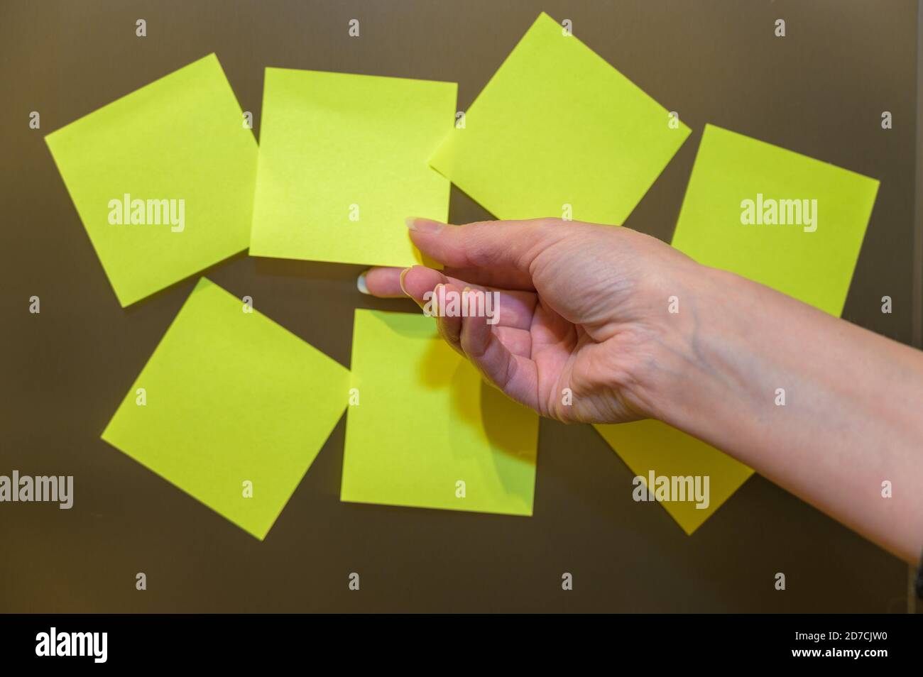 businesswoman attaching yellow sticky notes on flip chart. mockup with ...