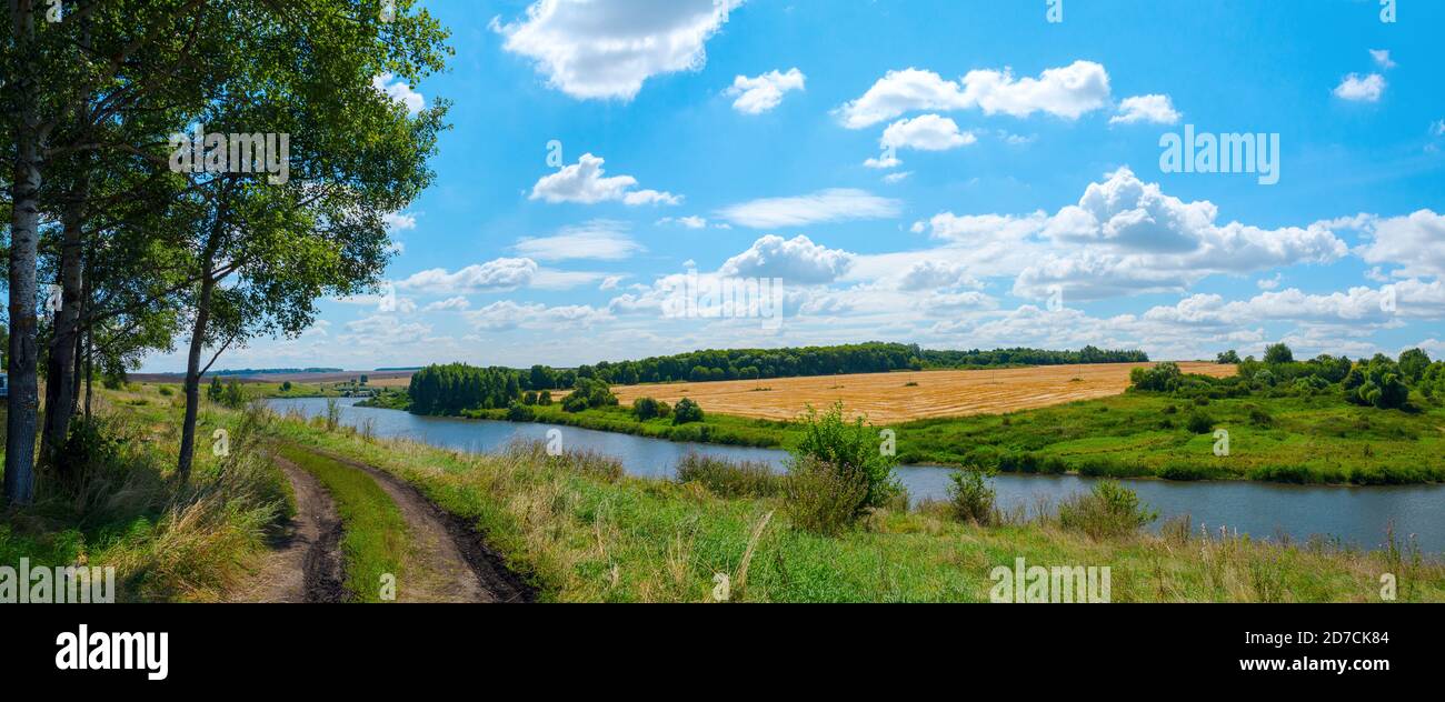 Sunny rural russian landscape with country road,river and golden fields ...