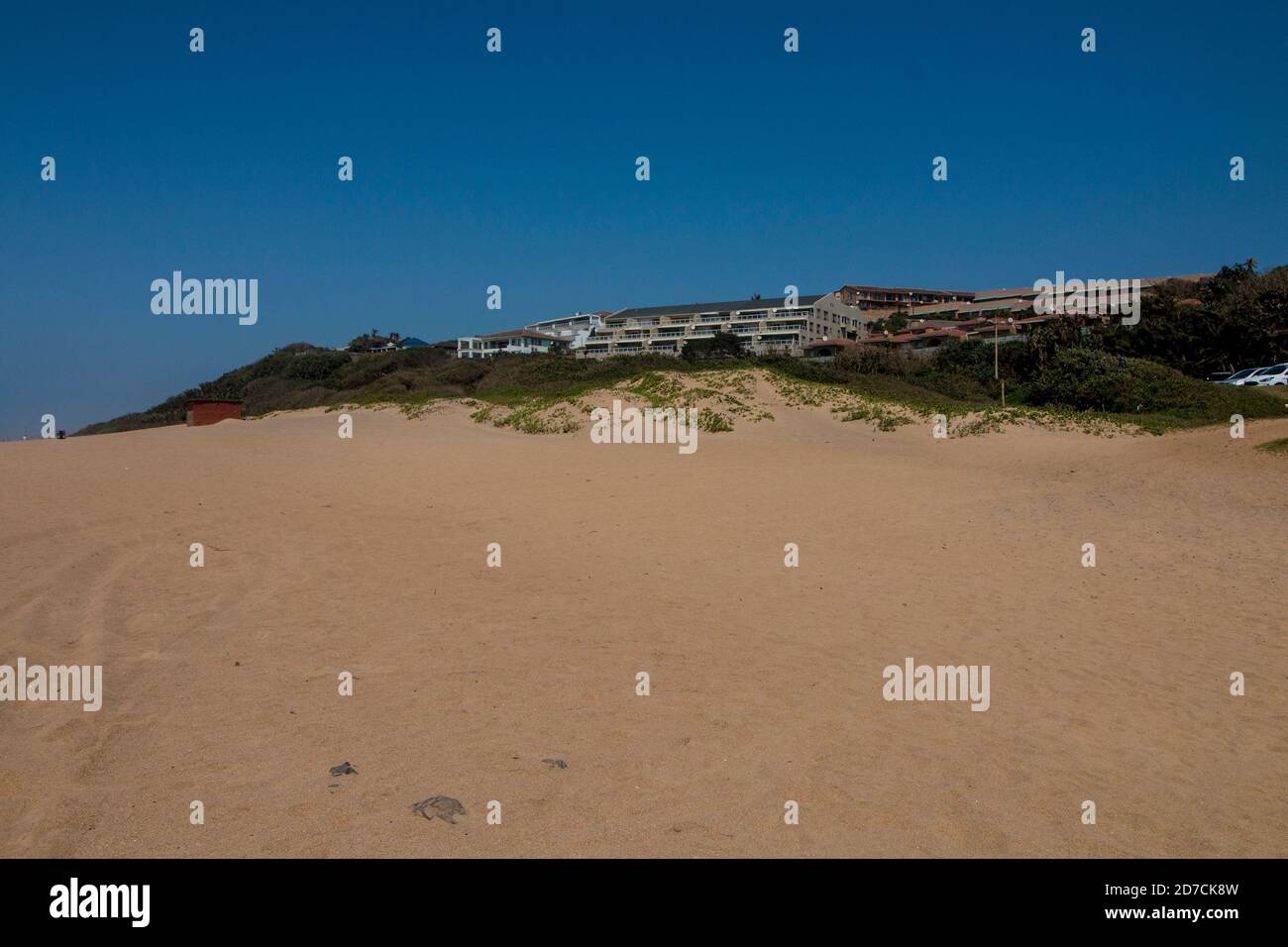 Wide stretch of beach sand before residential apartments Stock Photo ...