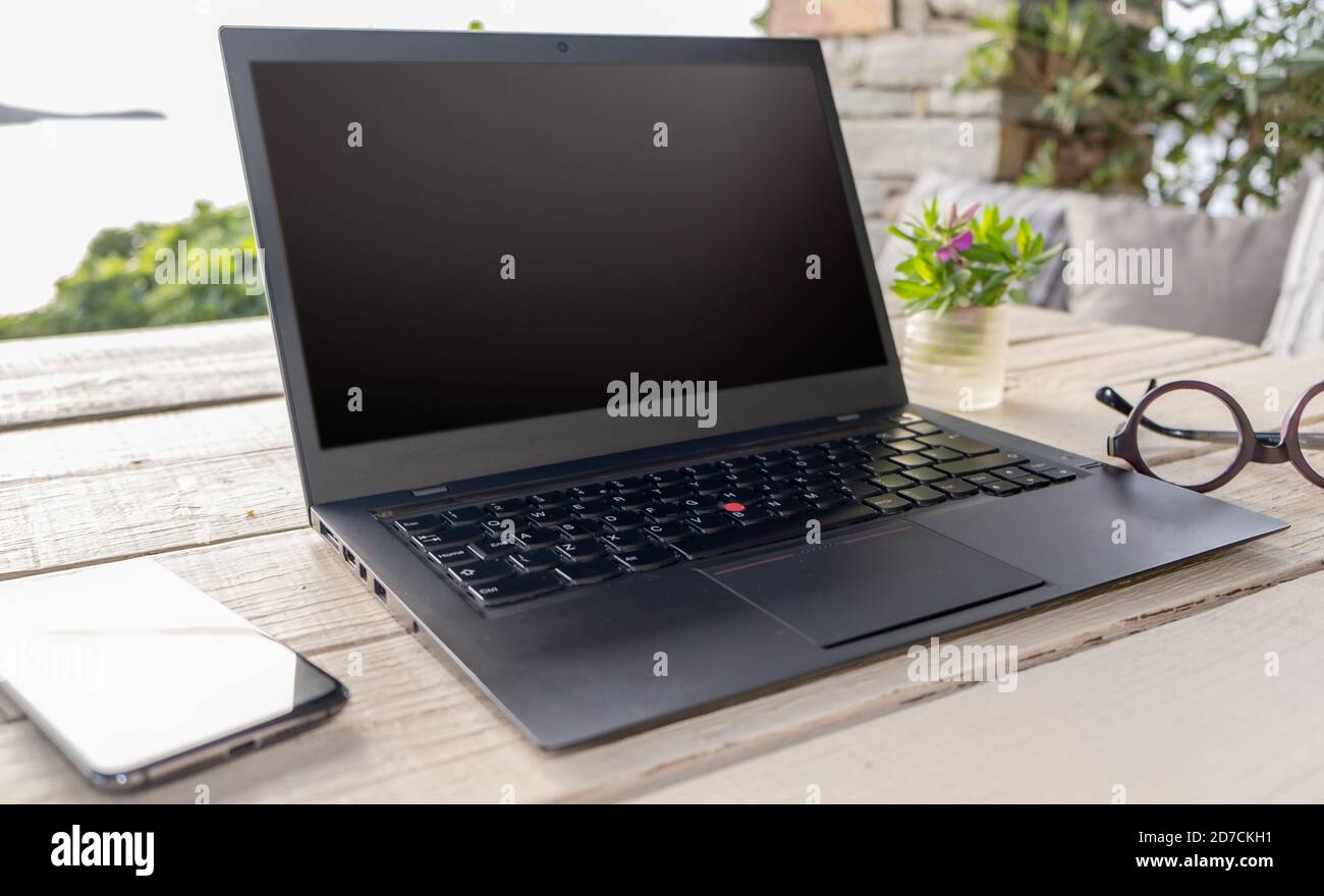 Blank screen computer on the table, green nature background, quarantine ...