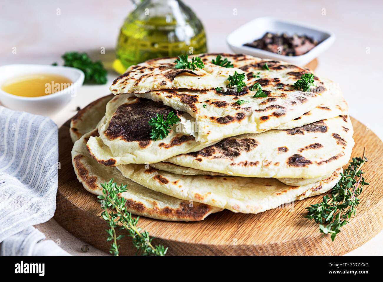 Indian homemade traditional flatbread with fresh parsley and olive oil ...