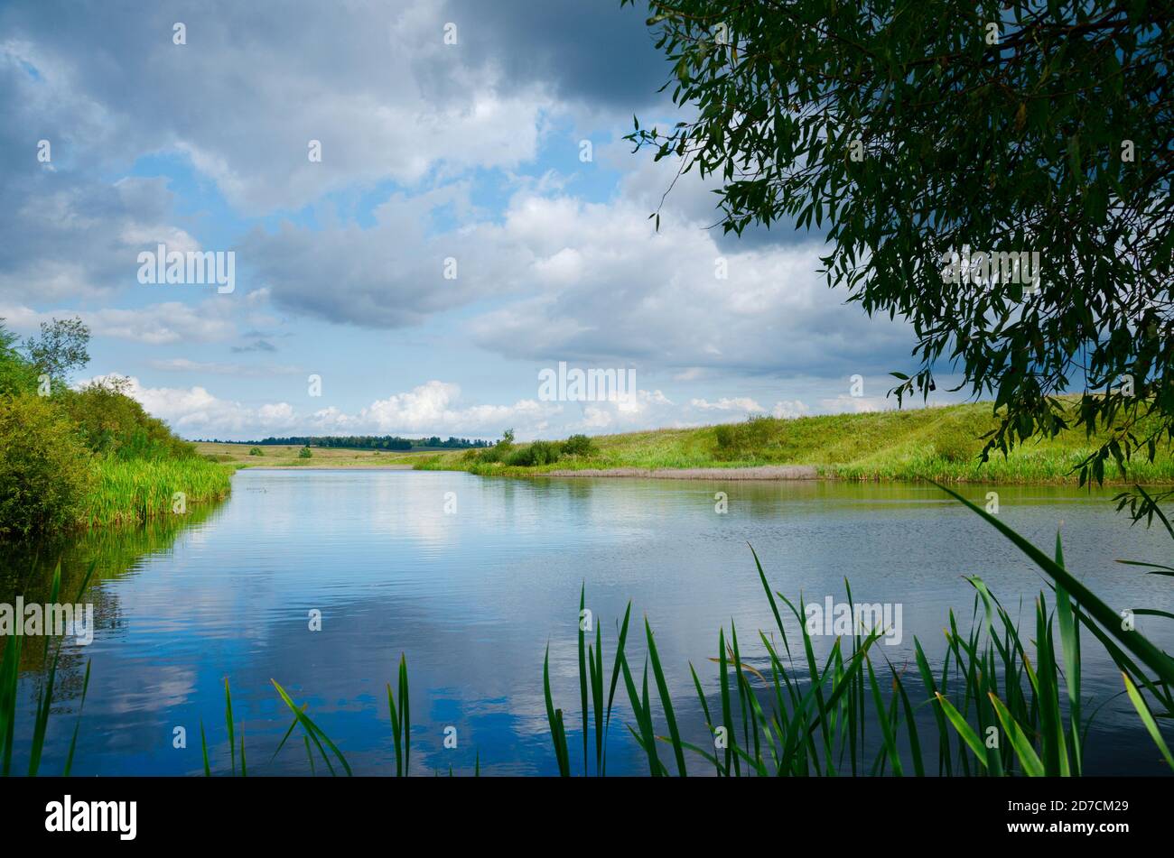 Beautiful panoramic view of river and dark clouds in sky Stock Photo ...