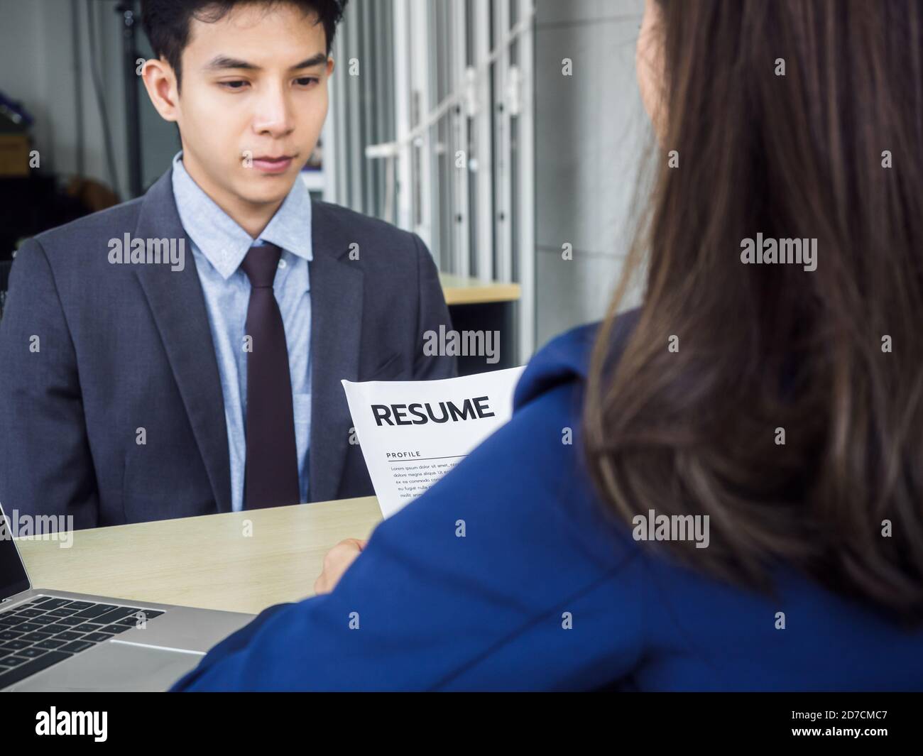 Resume or CV paper in employer 's hand and review the applicant profile ...