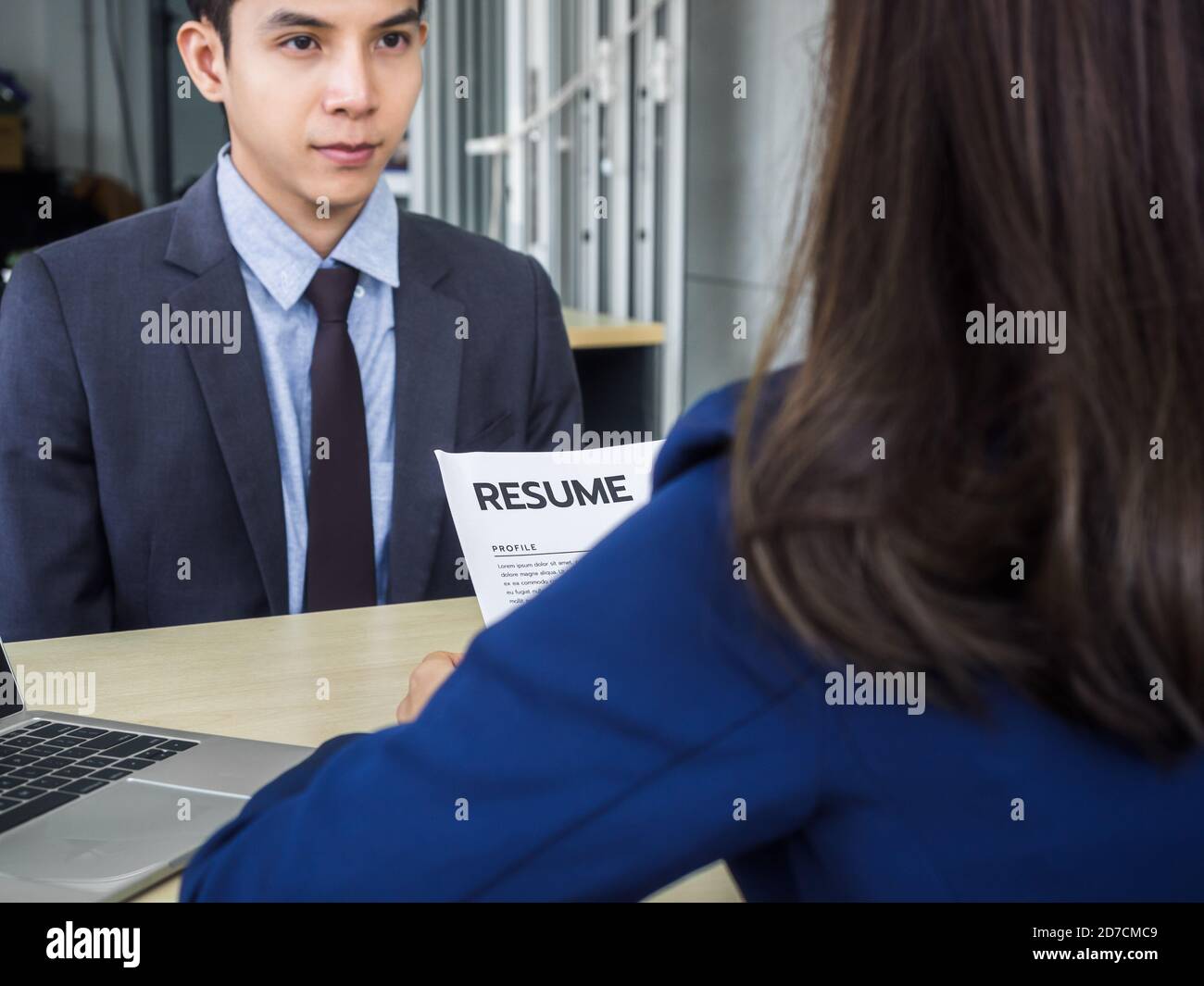 Resume or CV paper in employer 's hand and review the applicant profile ...