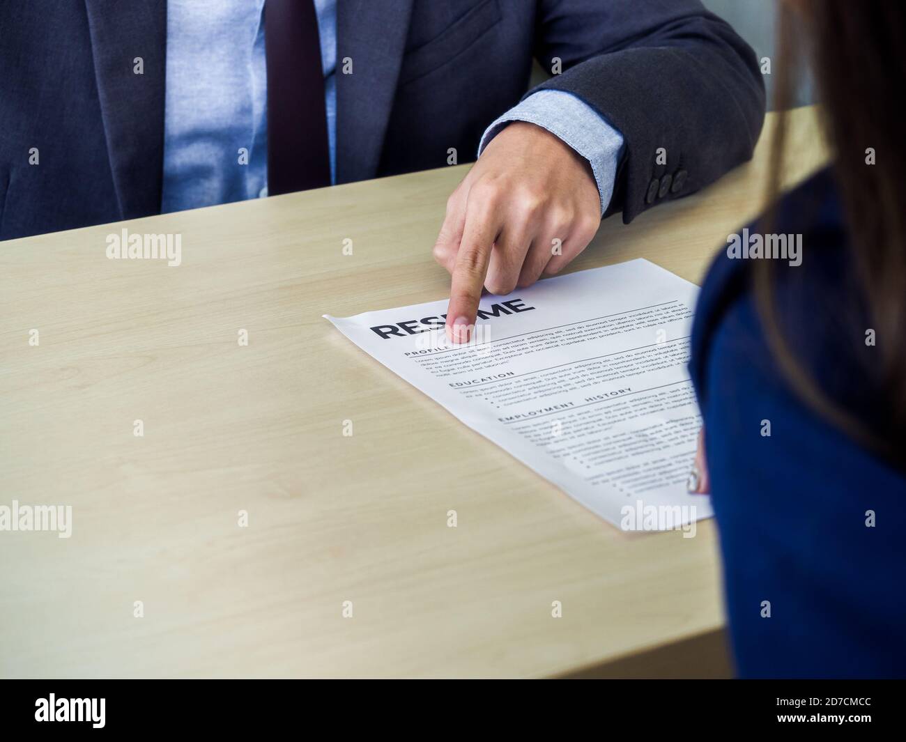 Businessman's finger pointing on his profile on resume or CV paper on ...