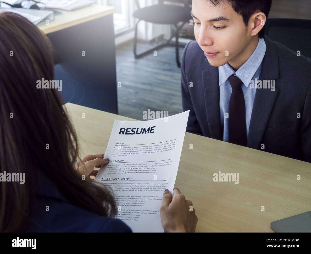 Resume or CV paper in employer 's hand and review the applicant profile ...