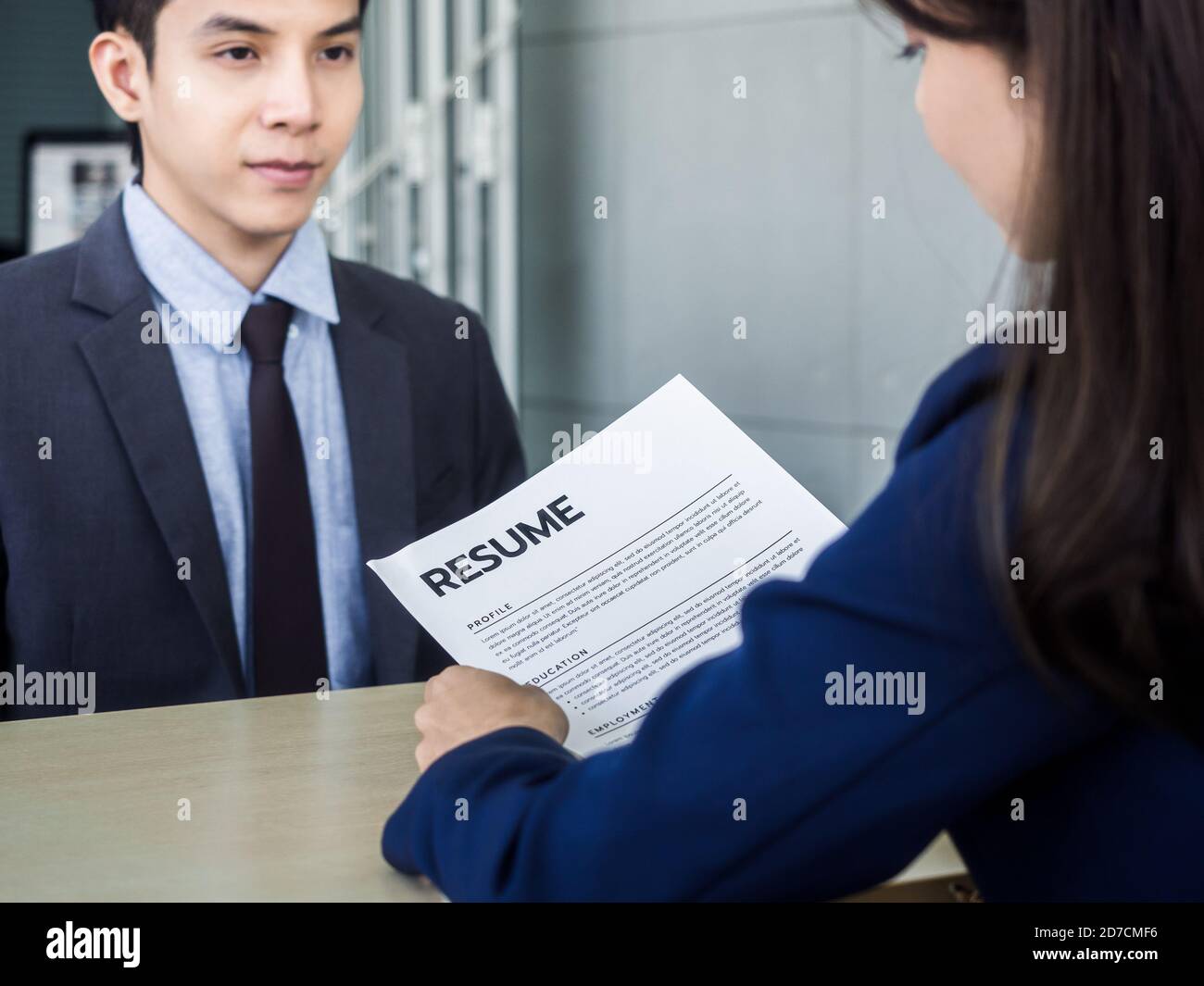 Resume or CV paper in employer 's hand and review the applicant profile ...