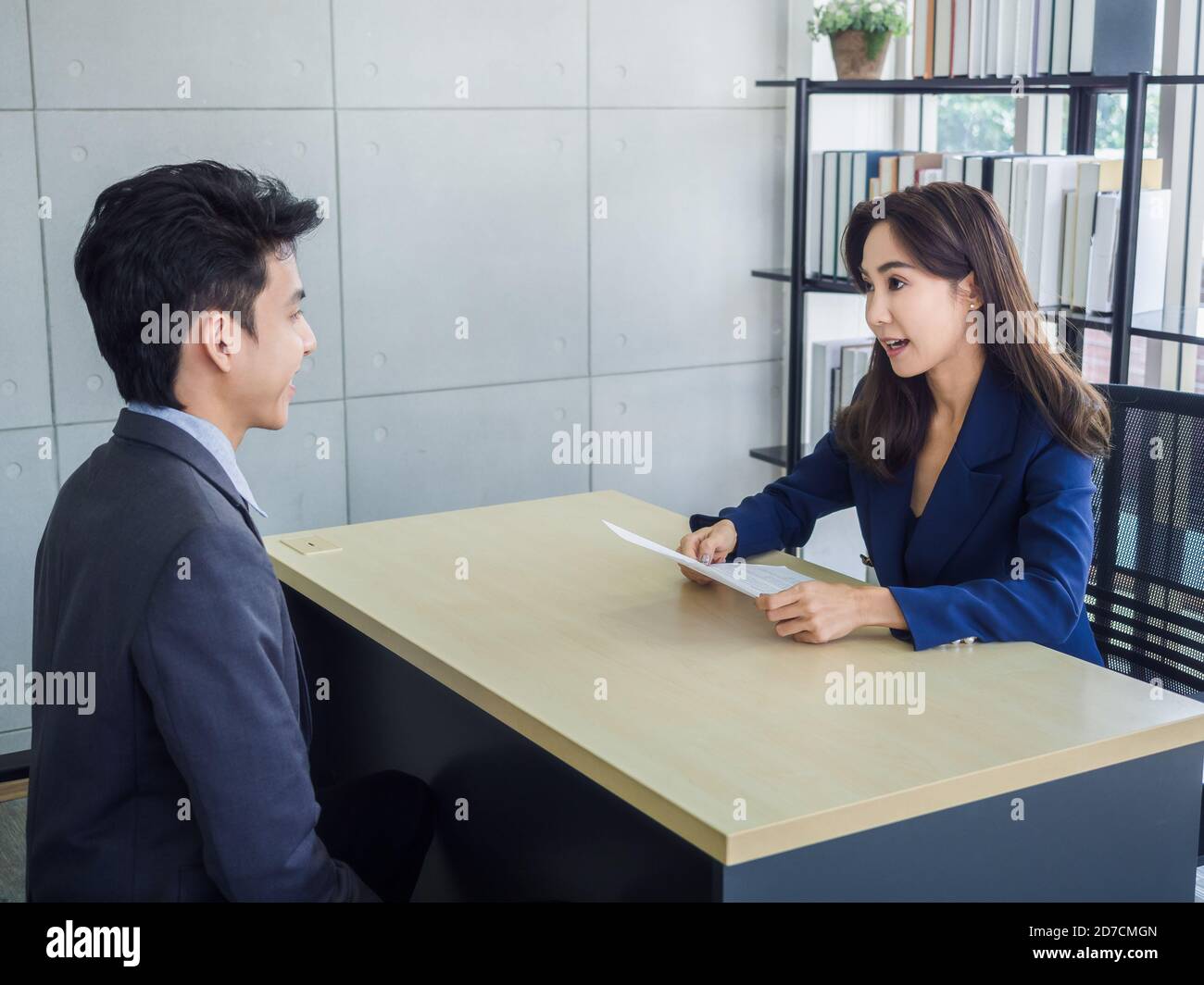 Asian businesswoman, HR review resume of young Asian business man in ...