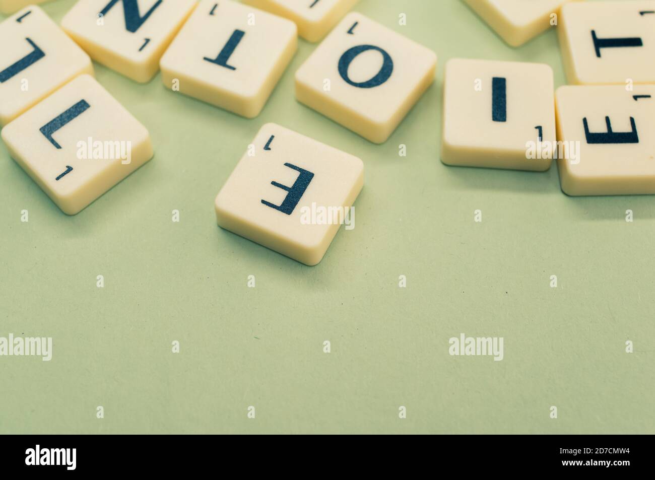 Closeup of the alphabet letters on the wooden pieces on the green ...