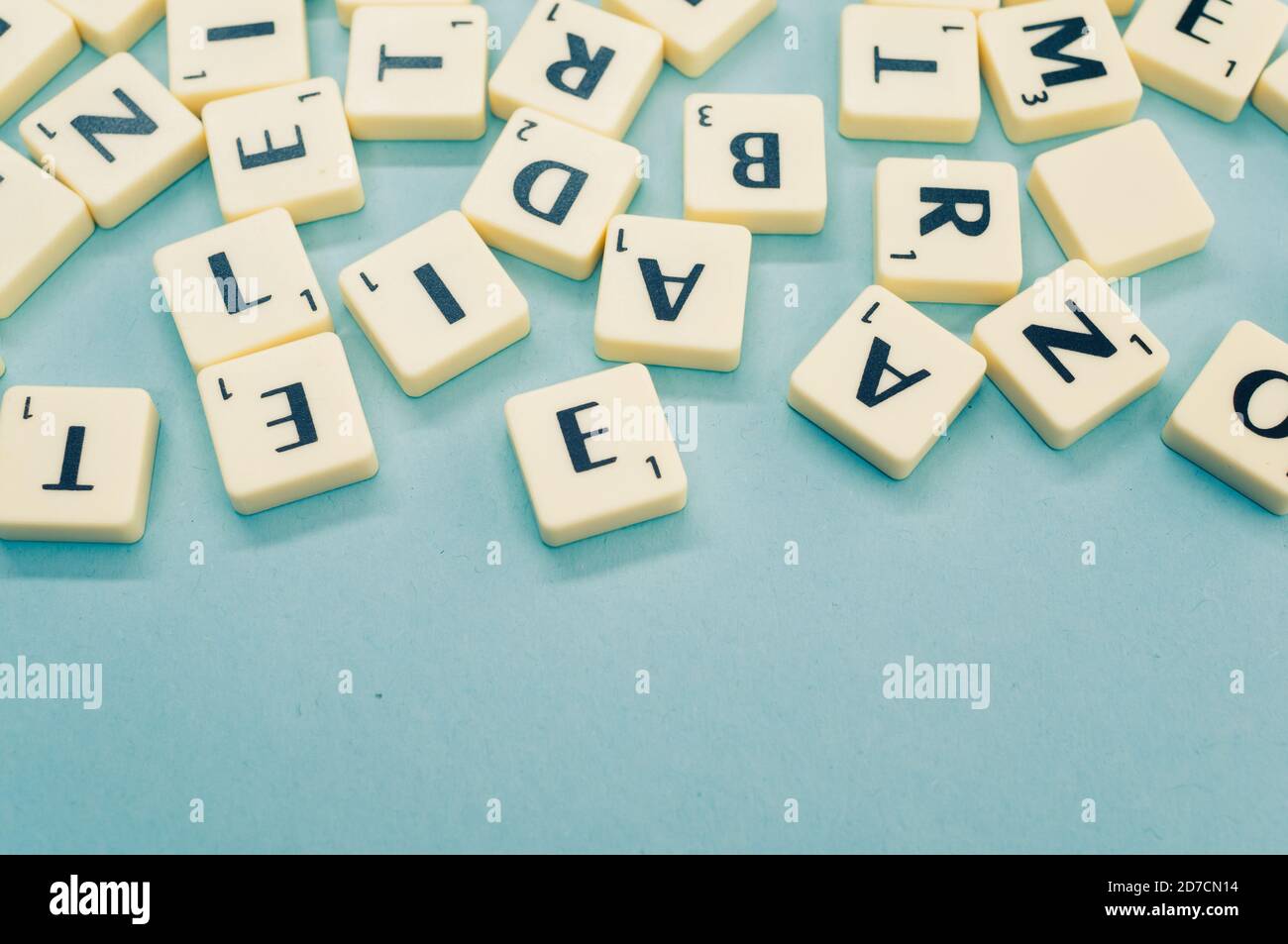Closeup of the alphabet letters on the wooden pieces on the blue ...