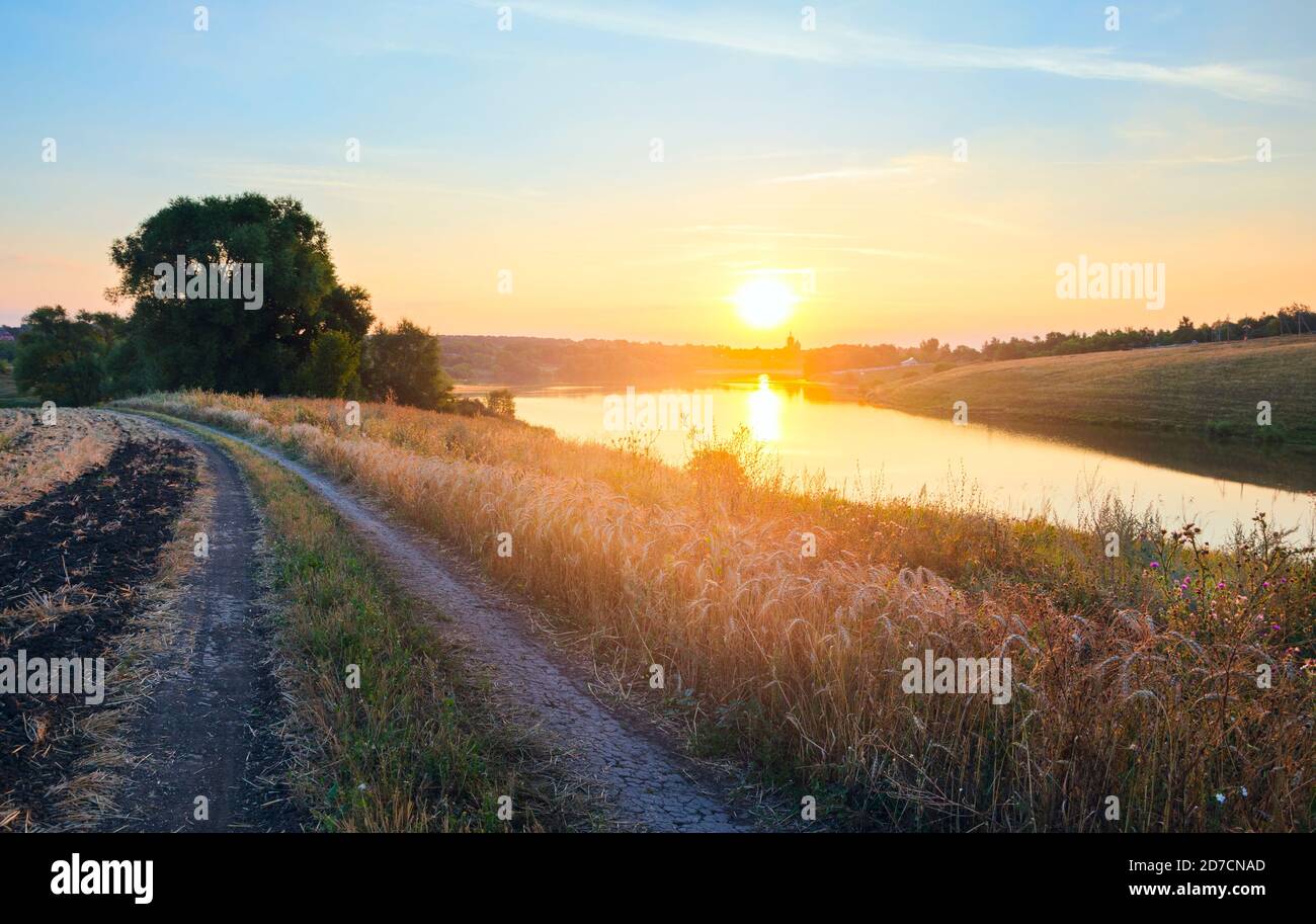 Sunny summer landscape with river and rising sun Stock Photo - Alamy