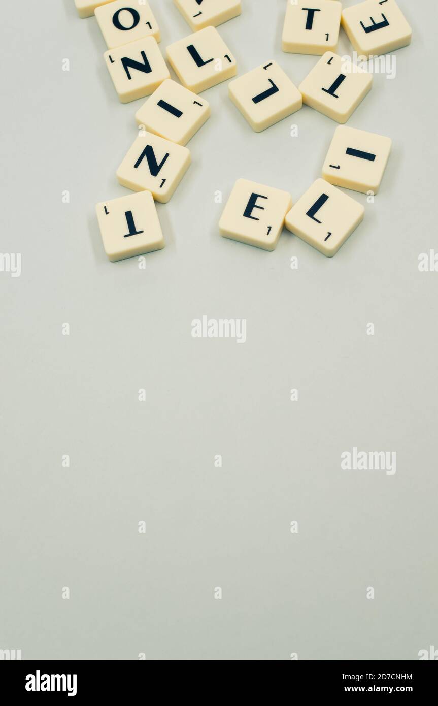 Closeup of the alphabet letters on the wooden pieces on the gray ...