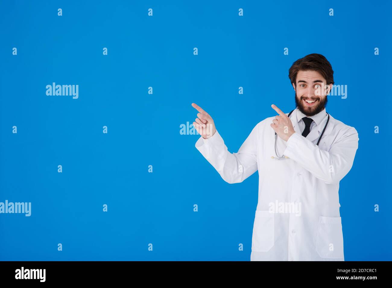 Horizontal banner of smiling young male doctor showing and presenting ...