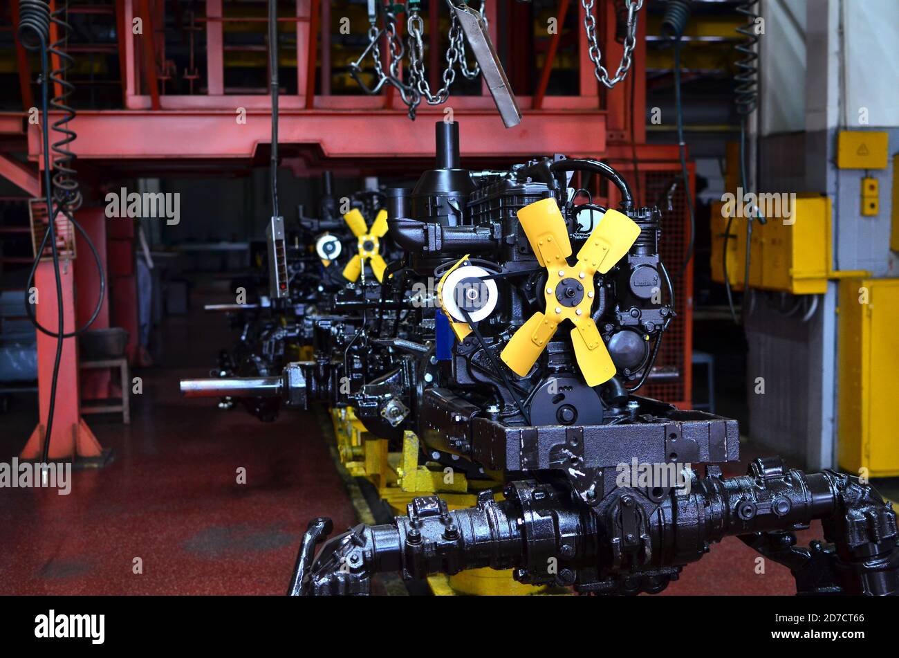 New engines on assembly line of industrial factory. Tractor Manufacture ...