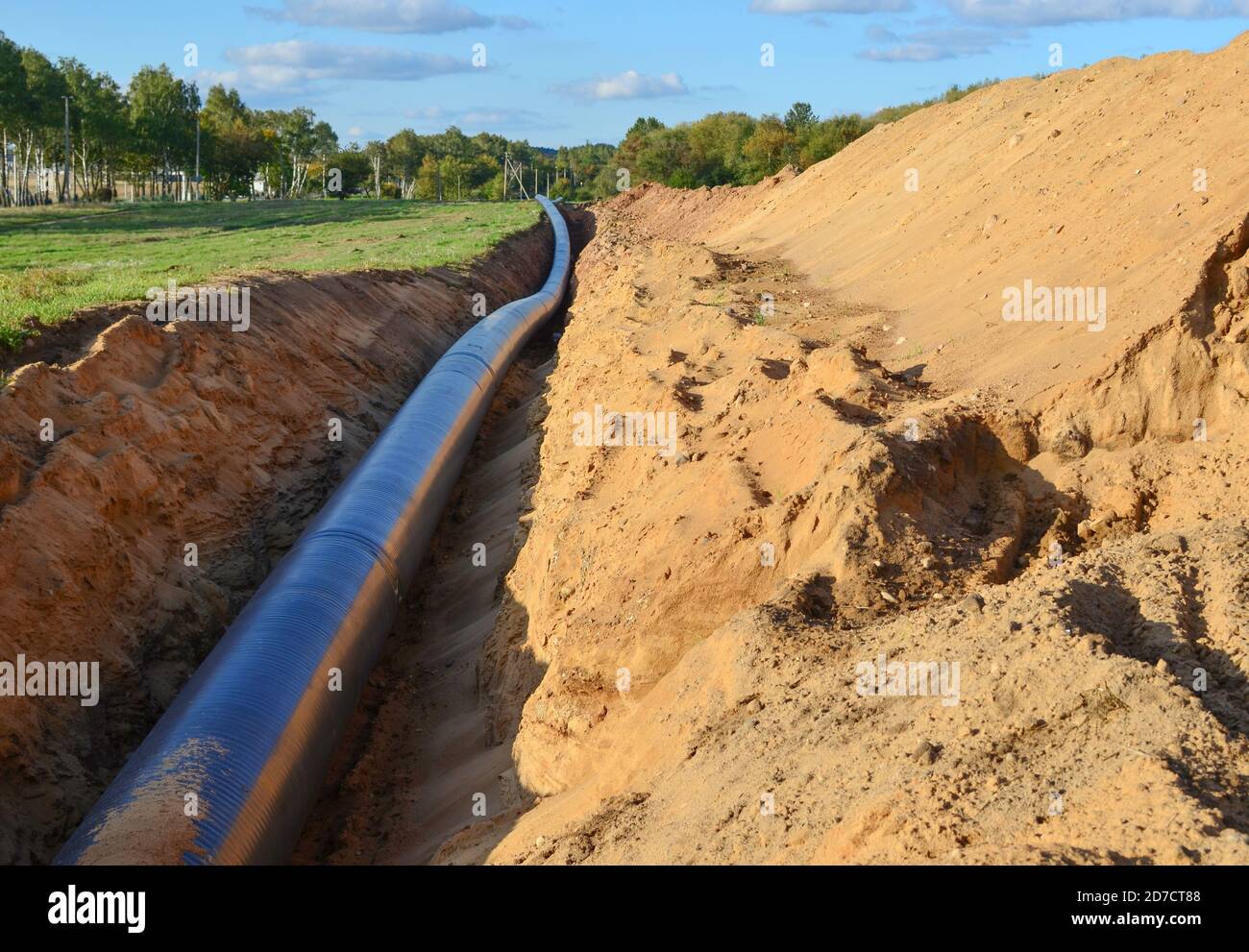Natural gas pipeline construction work. A dug trench in the ground for ...