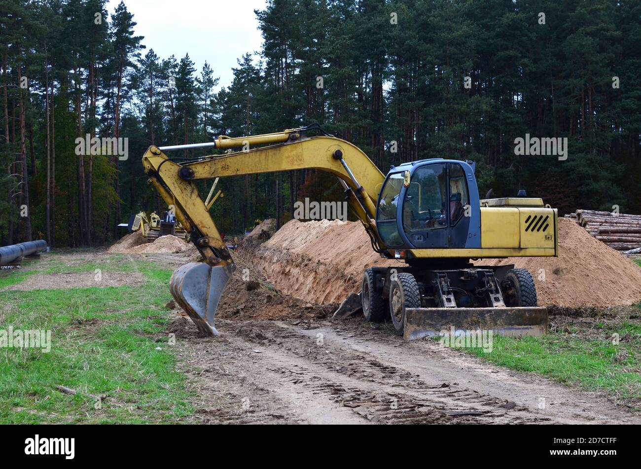 Excavator digs ground for the installation of industrial gas and oil ...