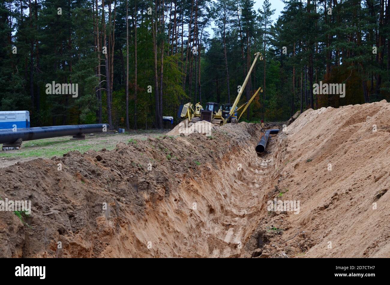 Natural gas pipeline construction work. A dug trench in the ground for ...