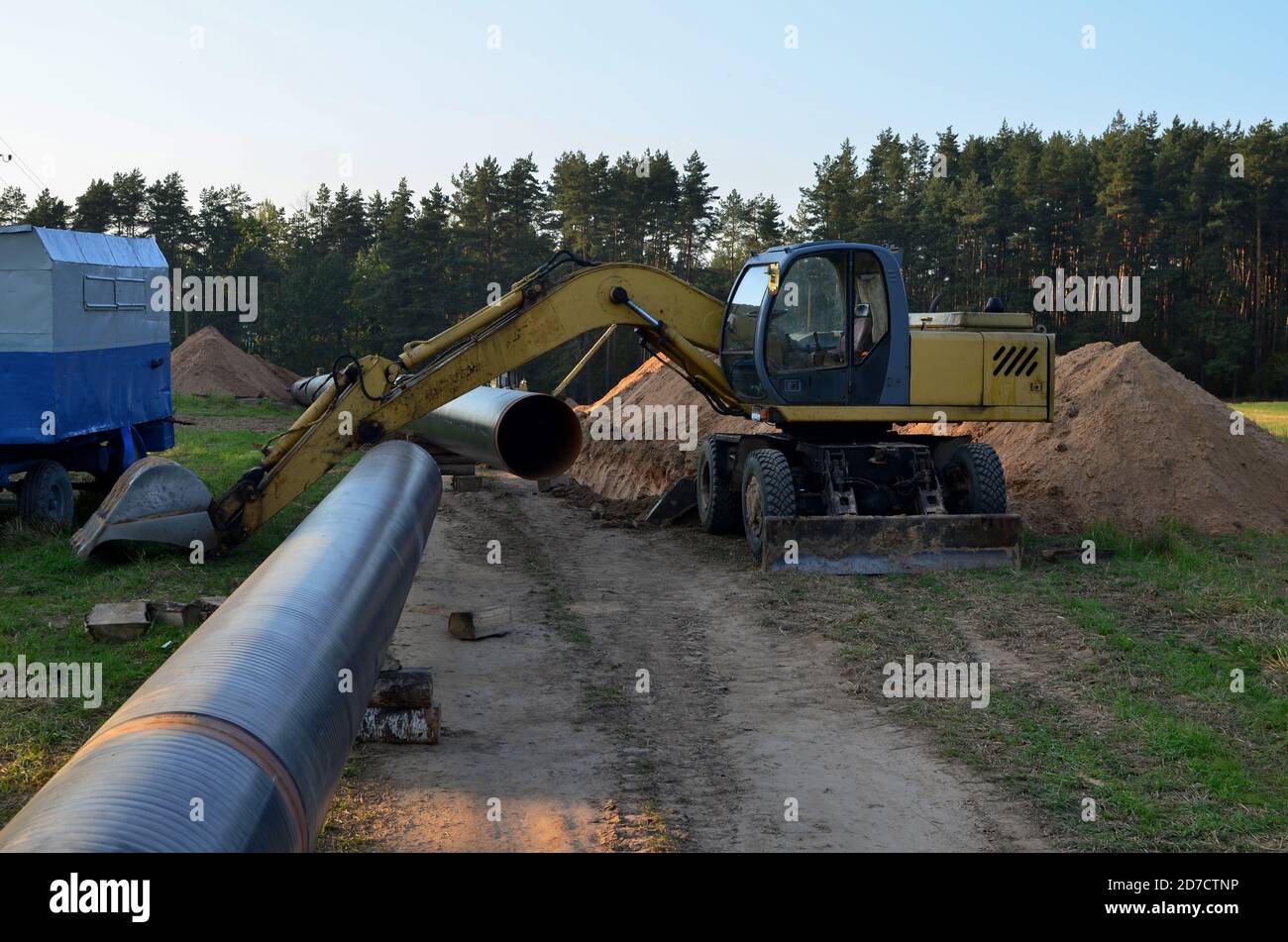 Excavator digs ground for the installation of industrial gas and oil ...