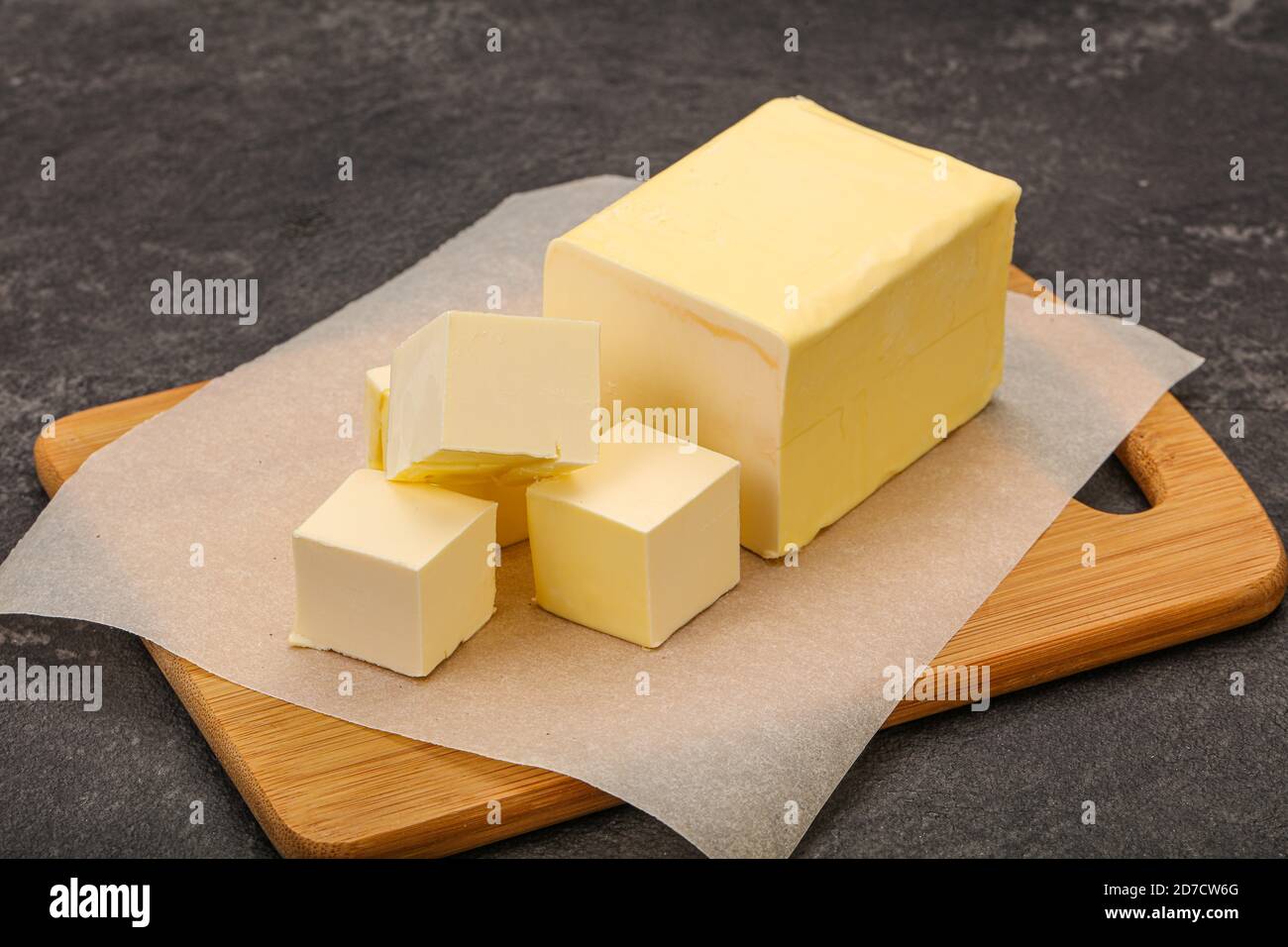 Dairy natural yellow butter piece over board Stock Photo - Alamy