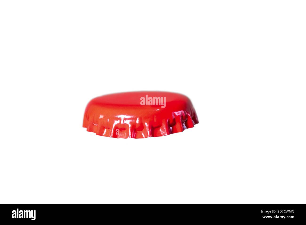 Closeup shot of the side of a red metal bottle cap isolated on white ...