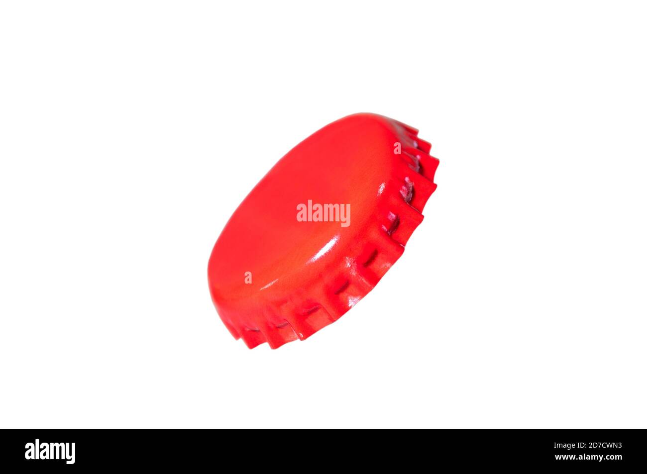 Closeup shot of the top side of a red metal bottle cap isolated on ...
