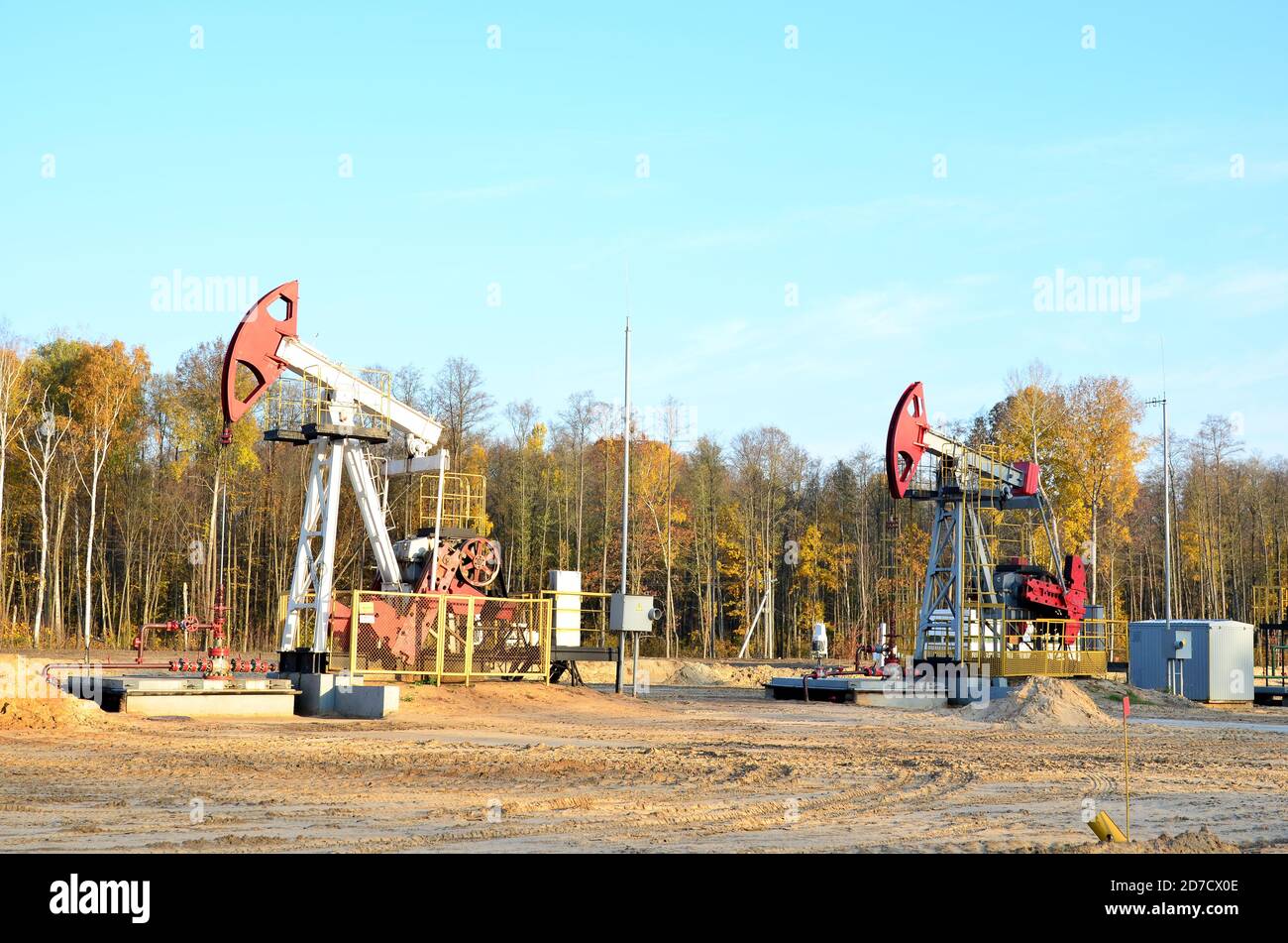 Oil drilling derricks at desert oilfield for fossil fuels output and ...