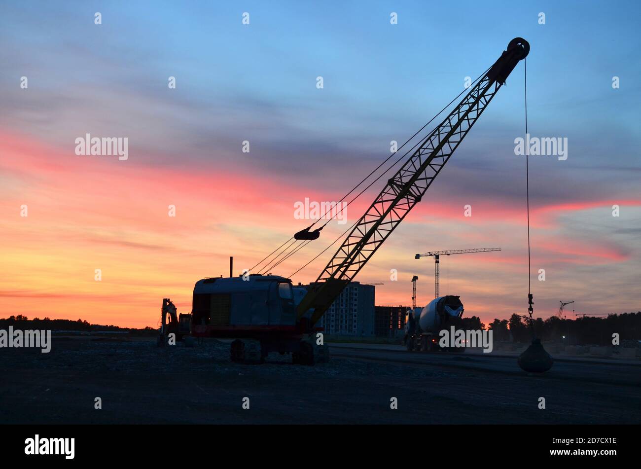 Crawler crane with a heavy metal wrecking ball on a steel cable ...