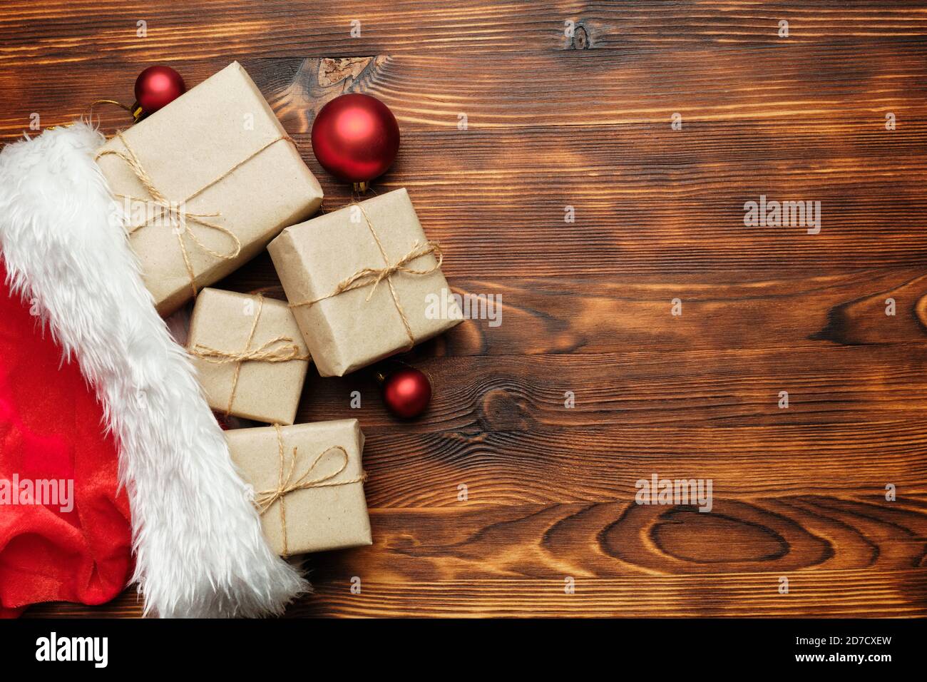 New year and christmas concept with hat and gifts on wooden background ...