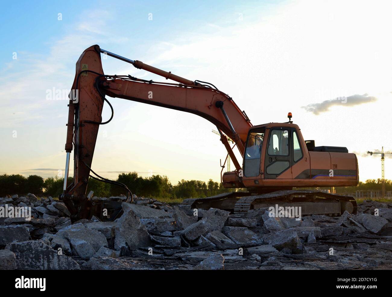 Crawler excavator with hydraulic breaker hammer on sunset. Destruction ...
