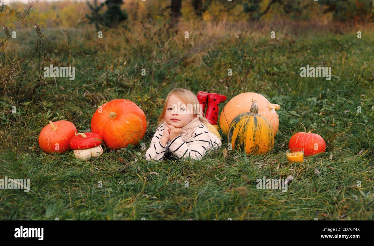 A brooding little child rests on his arms and looks into the distance ...