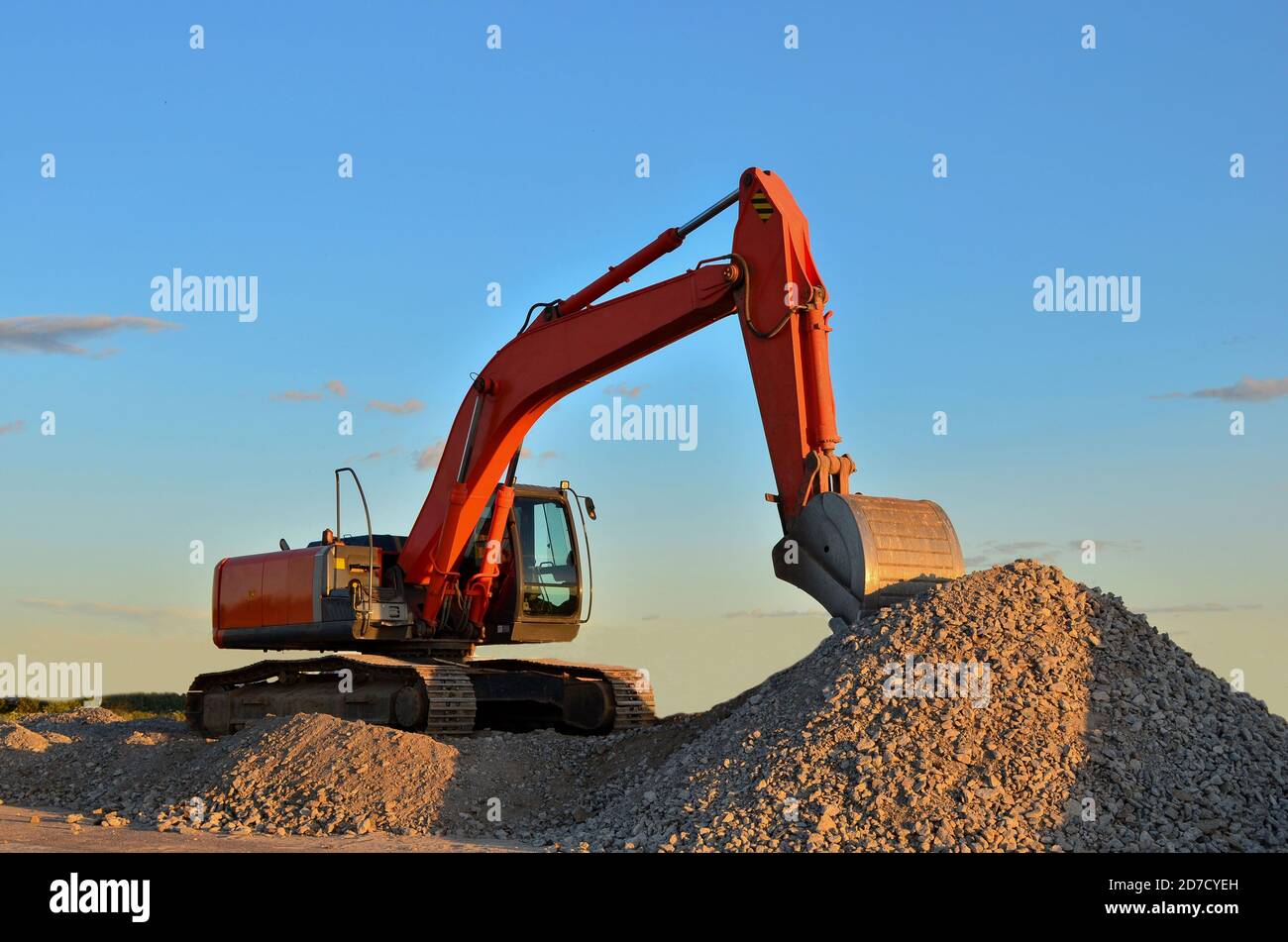 Excavator loads of stone and rubble for processing into cement or ...