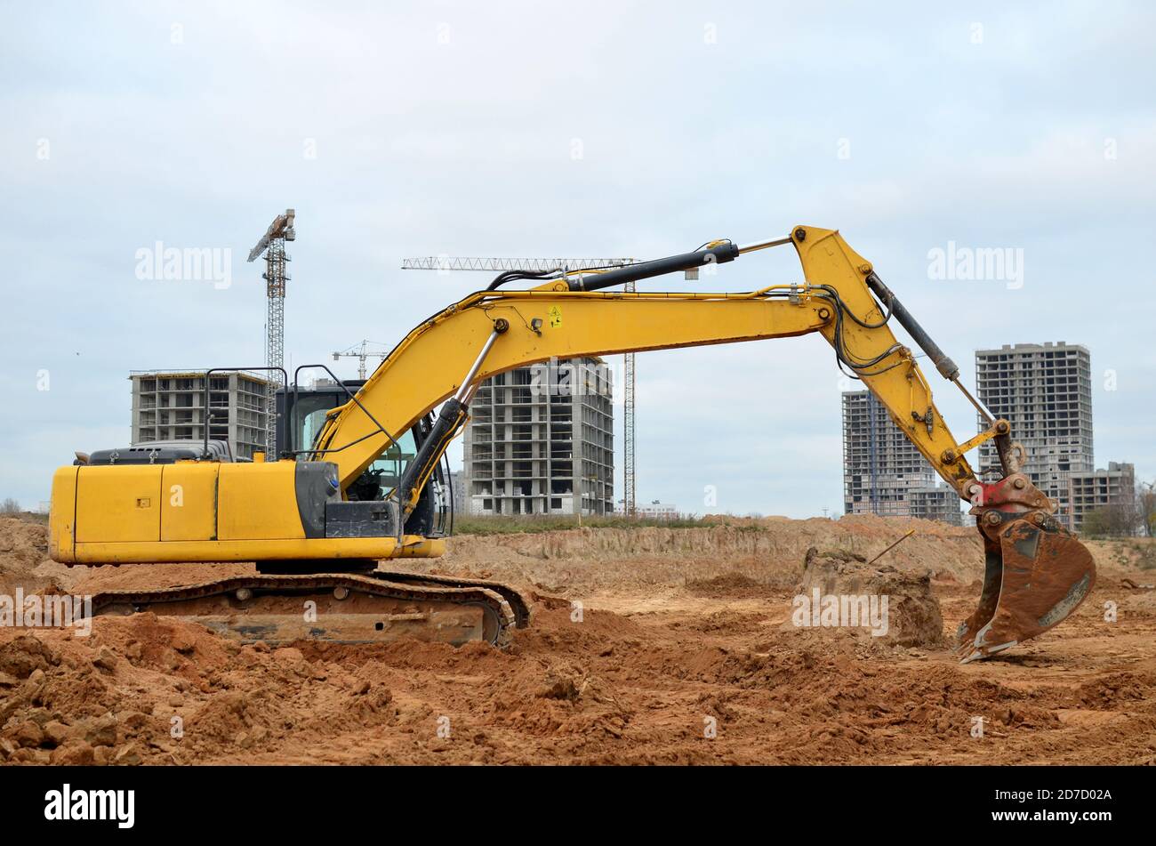 Excavator digs the ground for the foundation and construction of a new ...