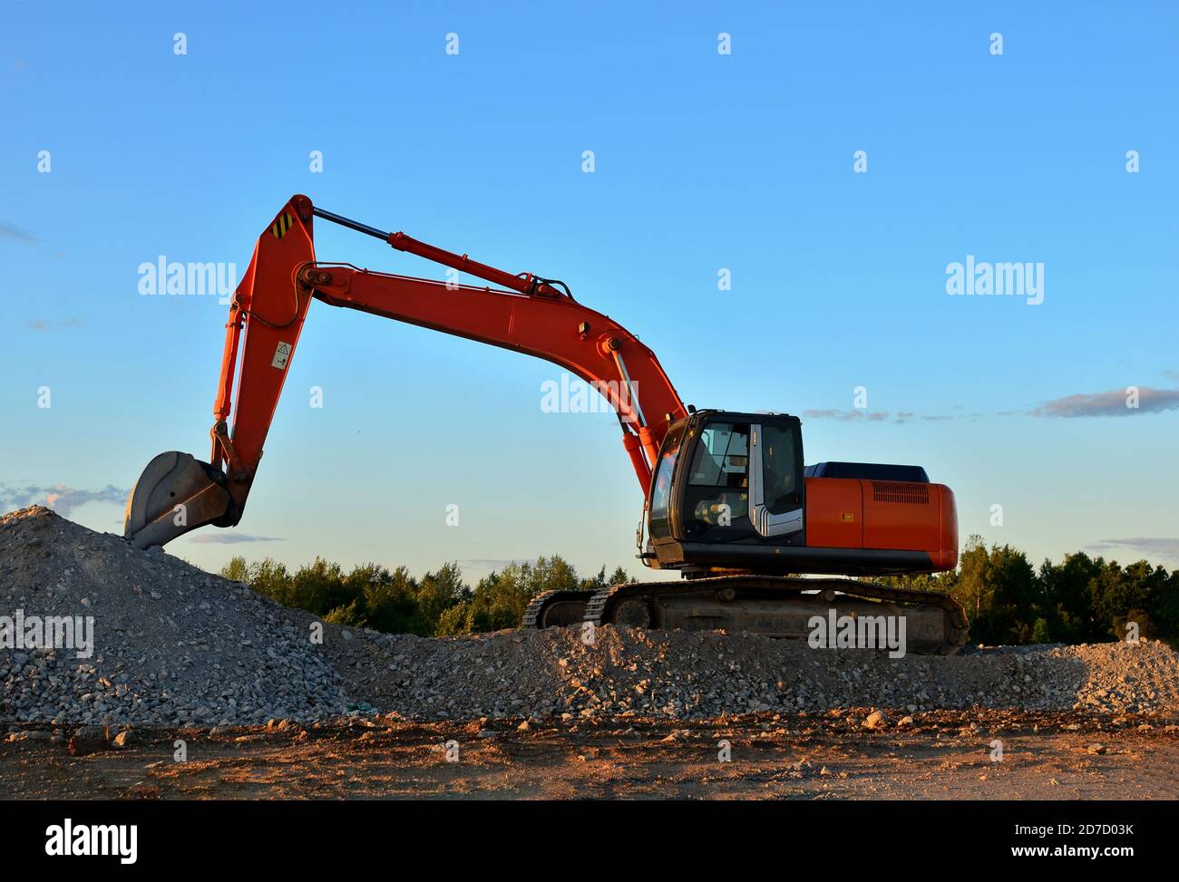 Excavator loads of stone and rubble for processing into cement or ...