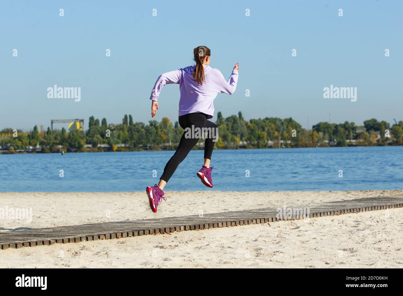 On the go. Young female athlete, woman training, practicing outdoors in ...