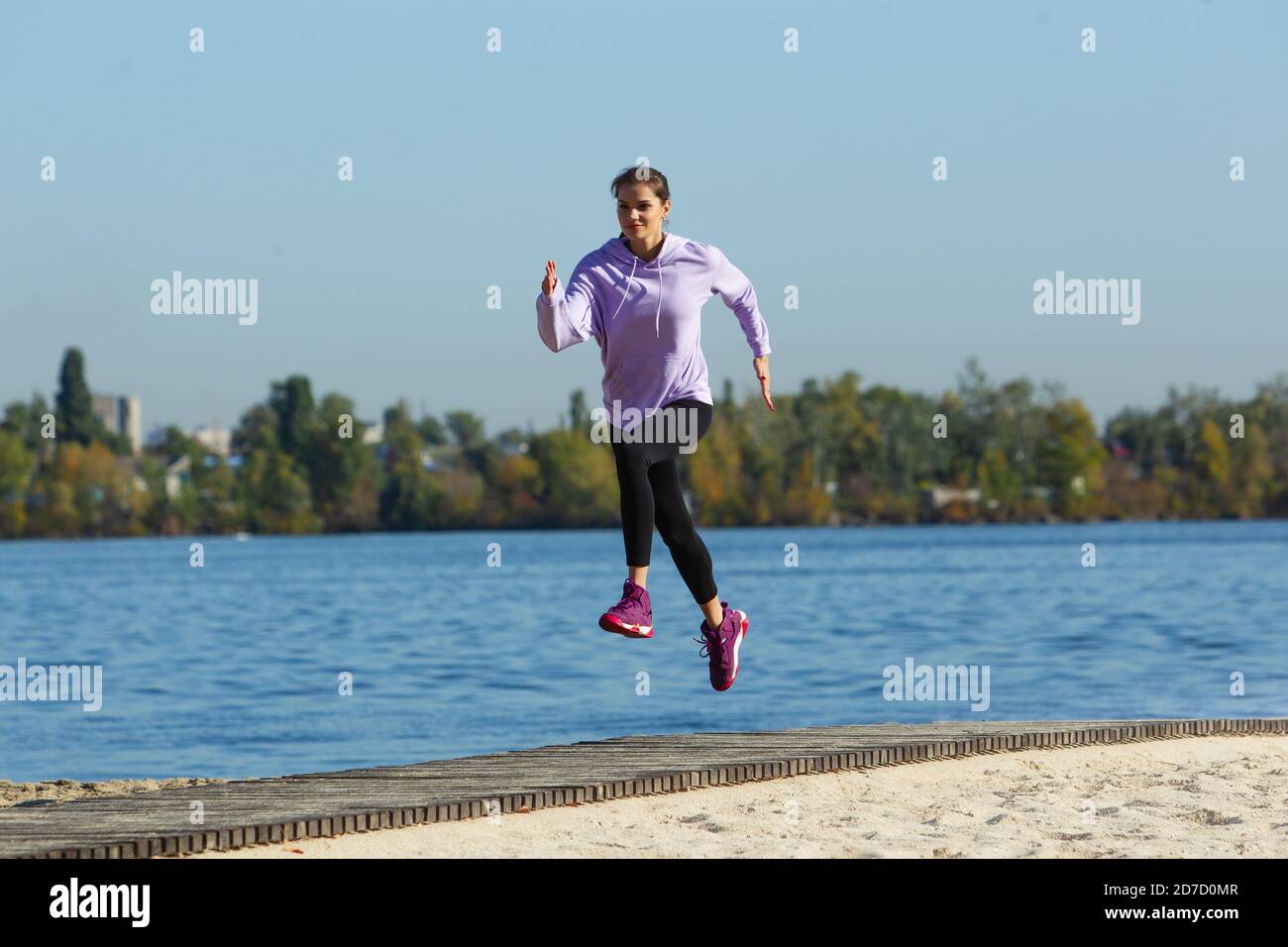 On the go. Young female athlete, woman training, practicing outdoors in ...