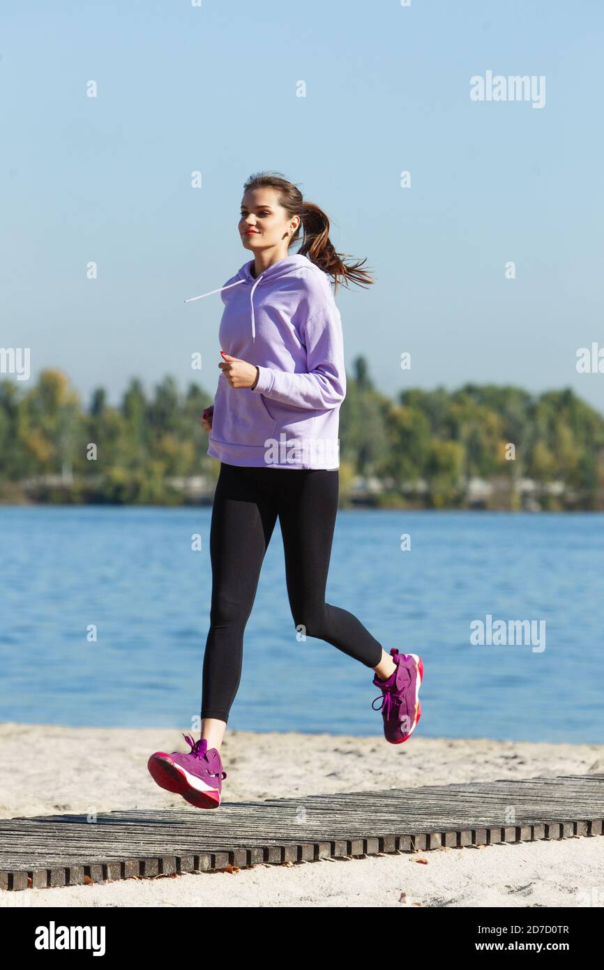 On the go. Young female athlete, woman training, practicing outdoors in ...