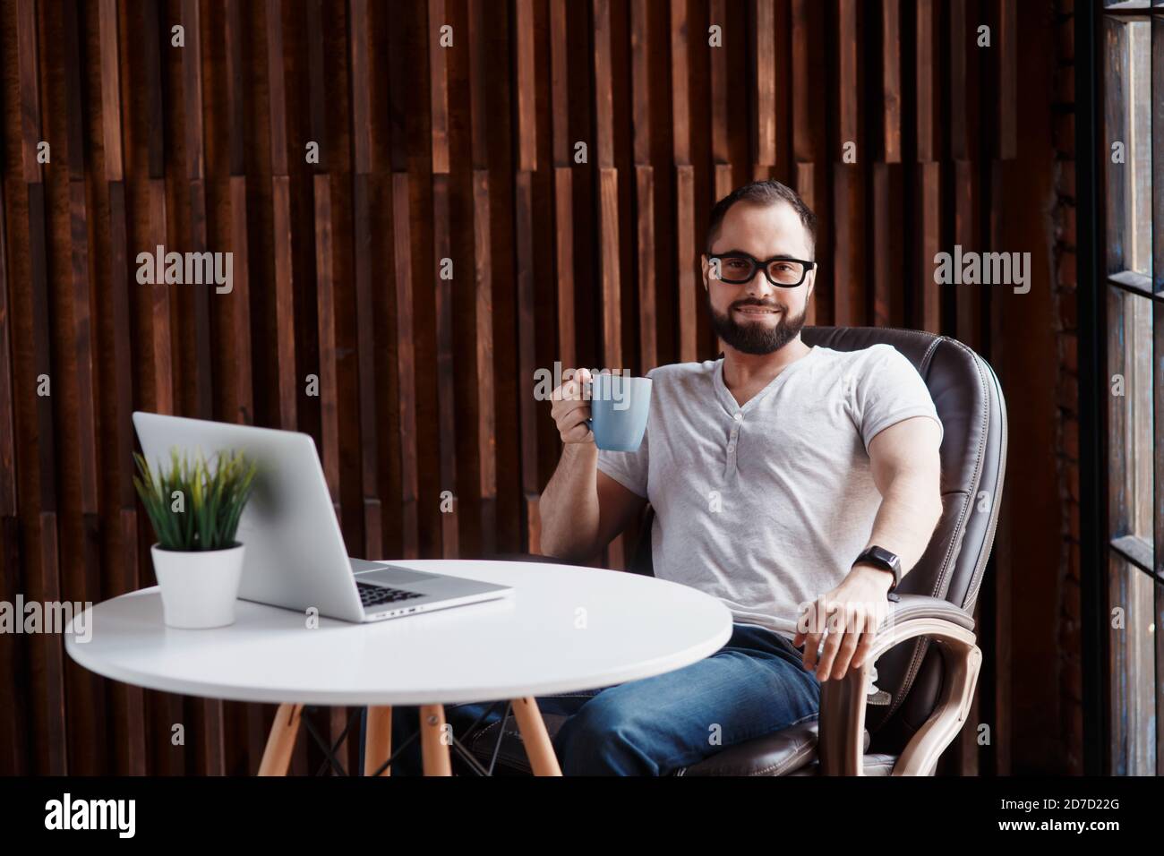 Young successful bearded businessman freelancer in office coworking ...