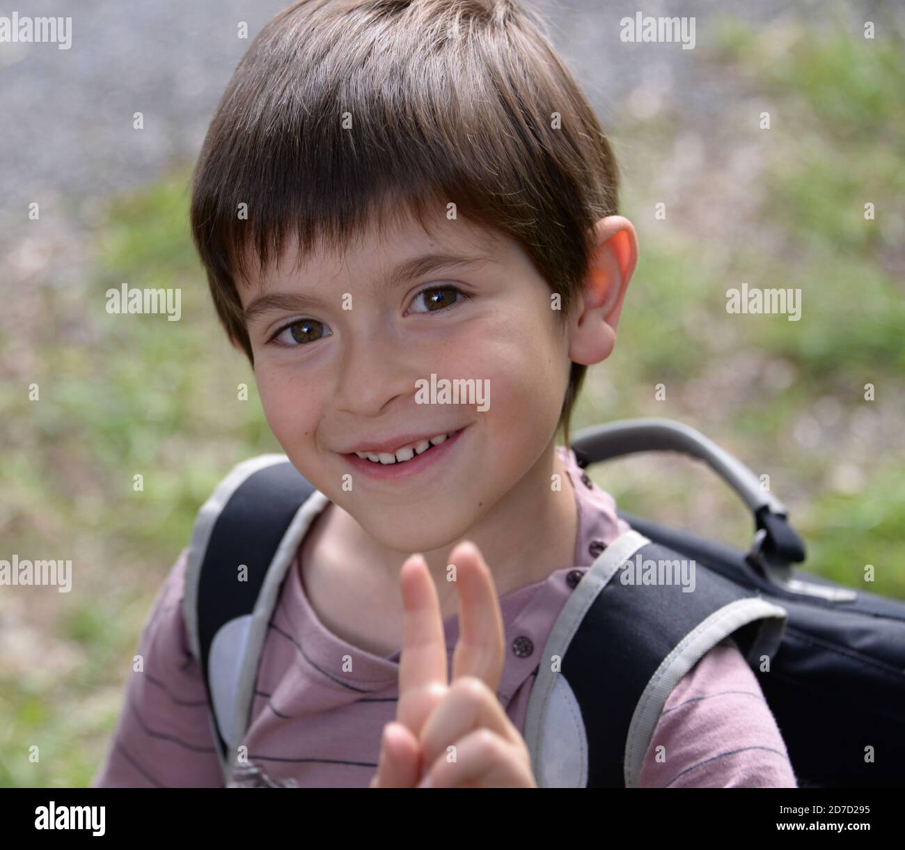 Little boy coming home from school with his schoolbag on his back Stock ...