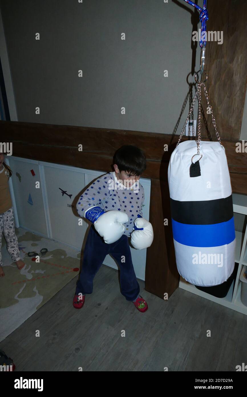 Little boy Boxing a training bag in his room Stock Photo - Alamy