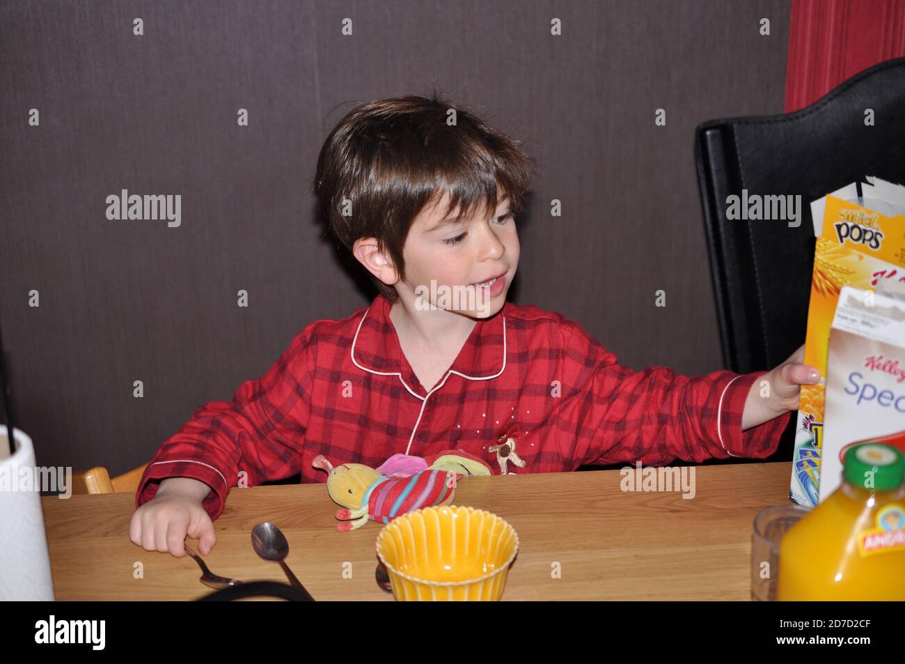 Little boy in pyjamas at breakfas with his blankie on the tablet Stock ...