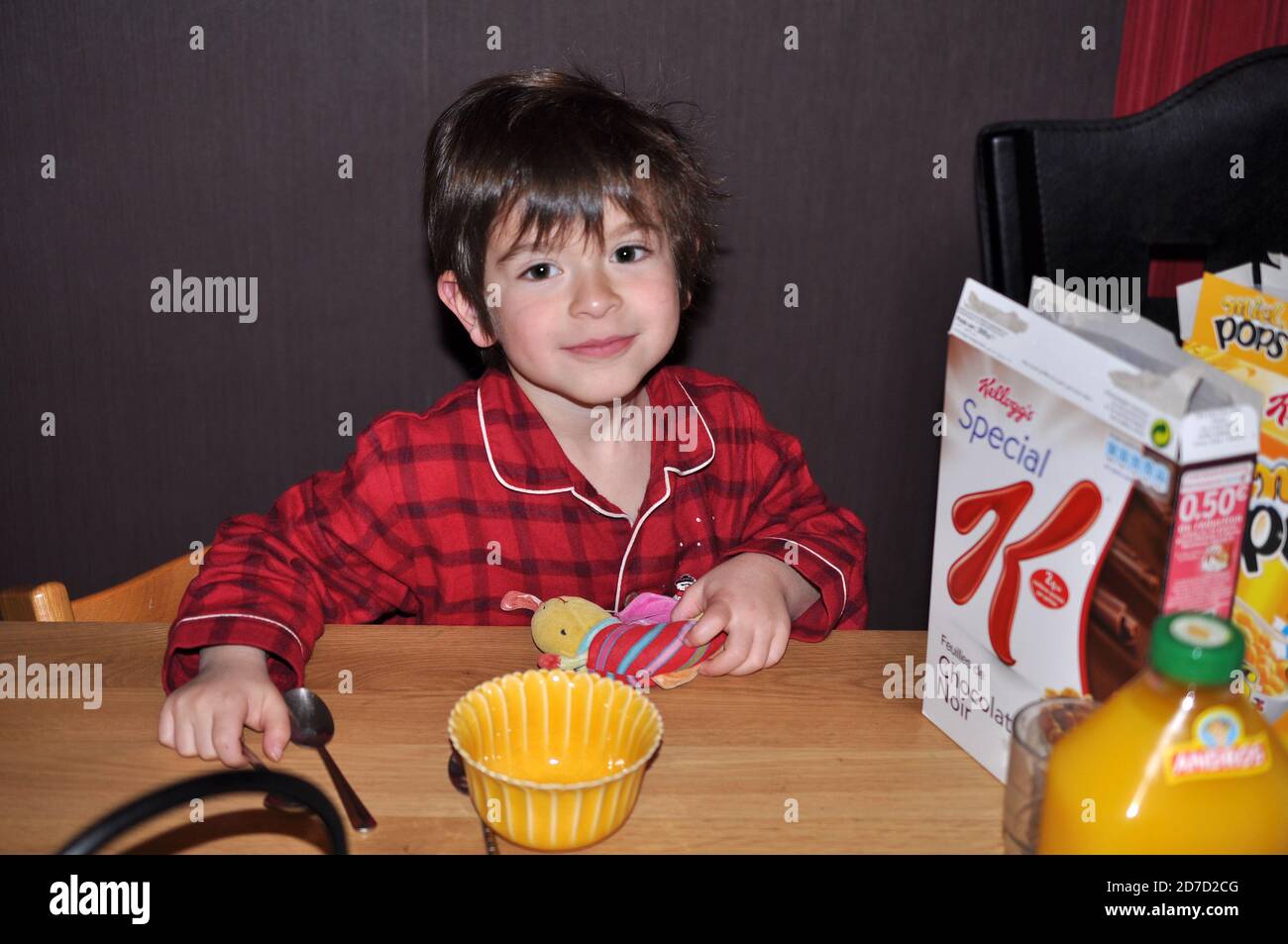 Little boy in pyjamas at breakfas with his blankie on the tablet Stock ...
