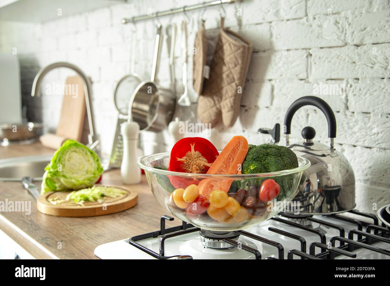 Modern stylish kitchen interior with vegetables and fruits on the table ...