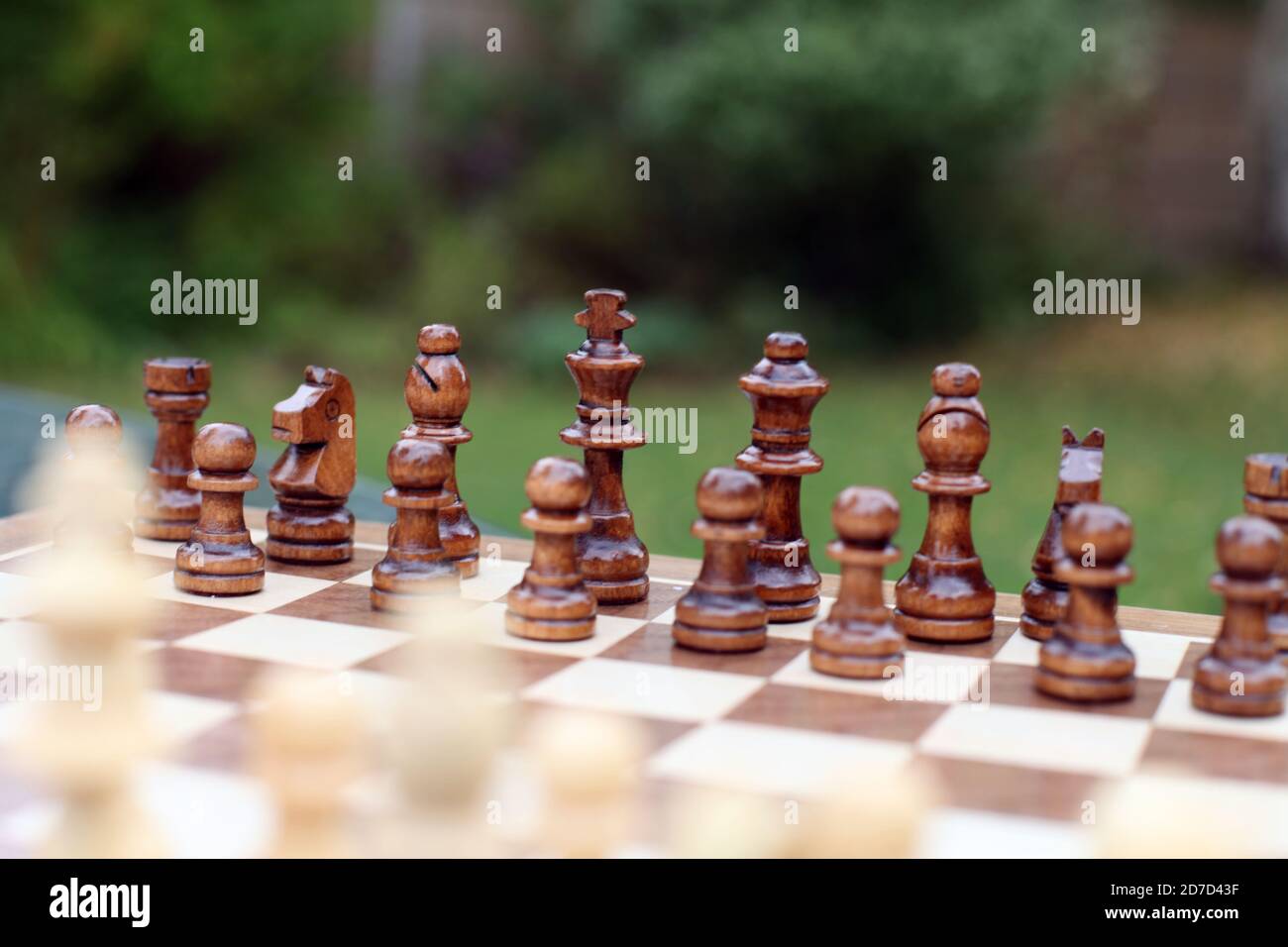 Chess pieces on chess board, outside, low depth of field, focus on ...